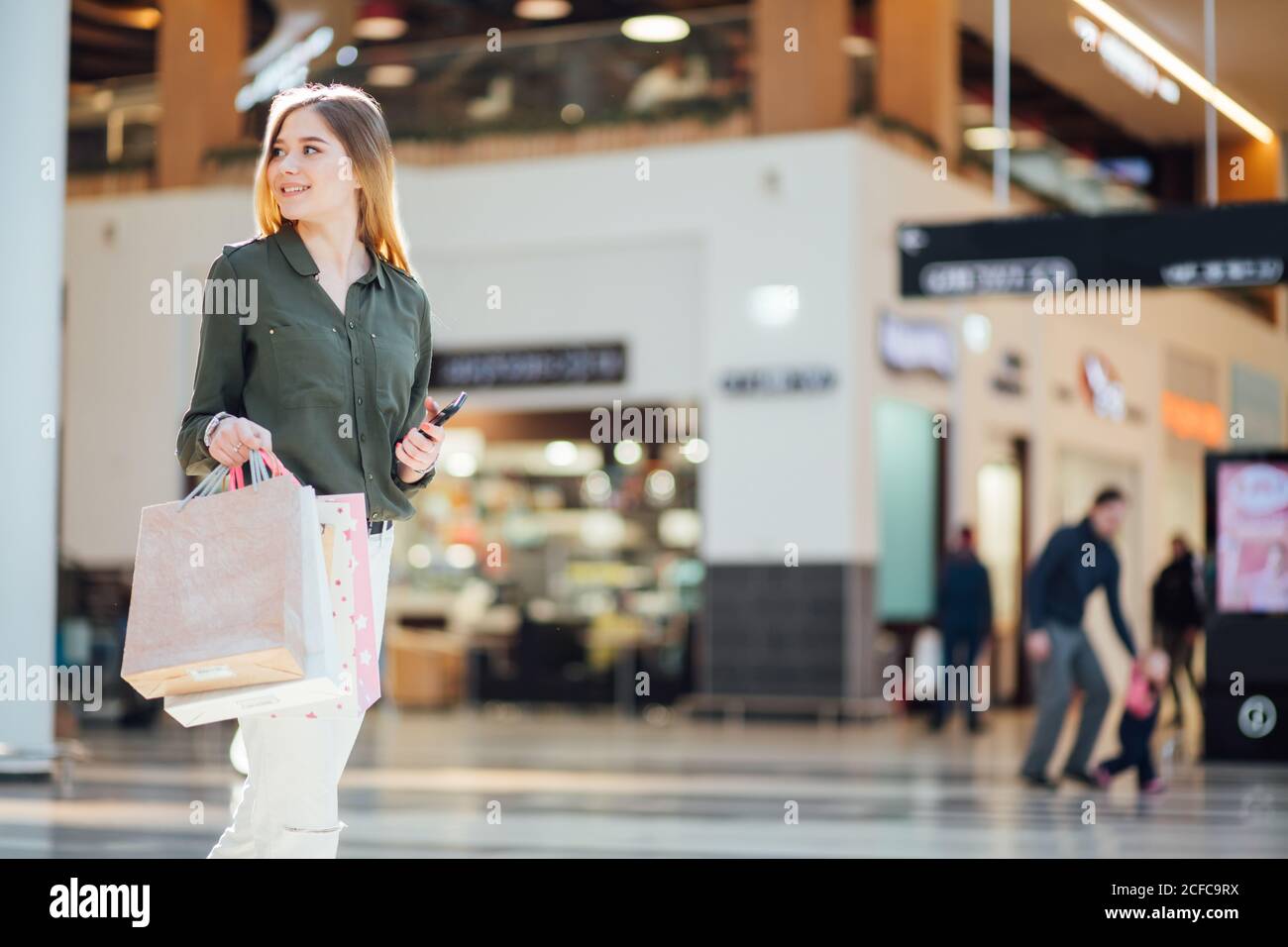 Young woman with shopping bags walking and shopping in shop Stock Photo ...