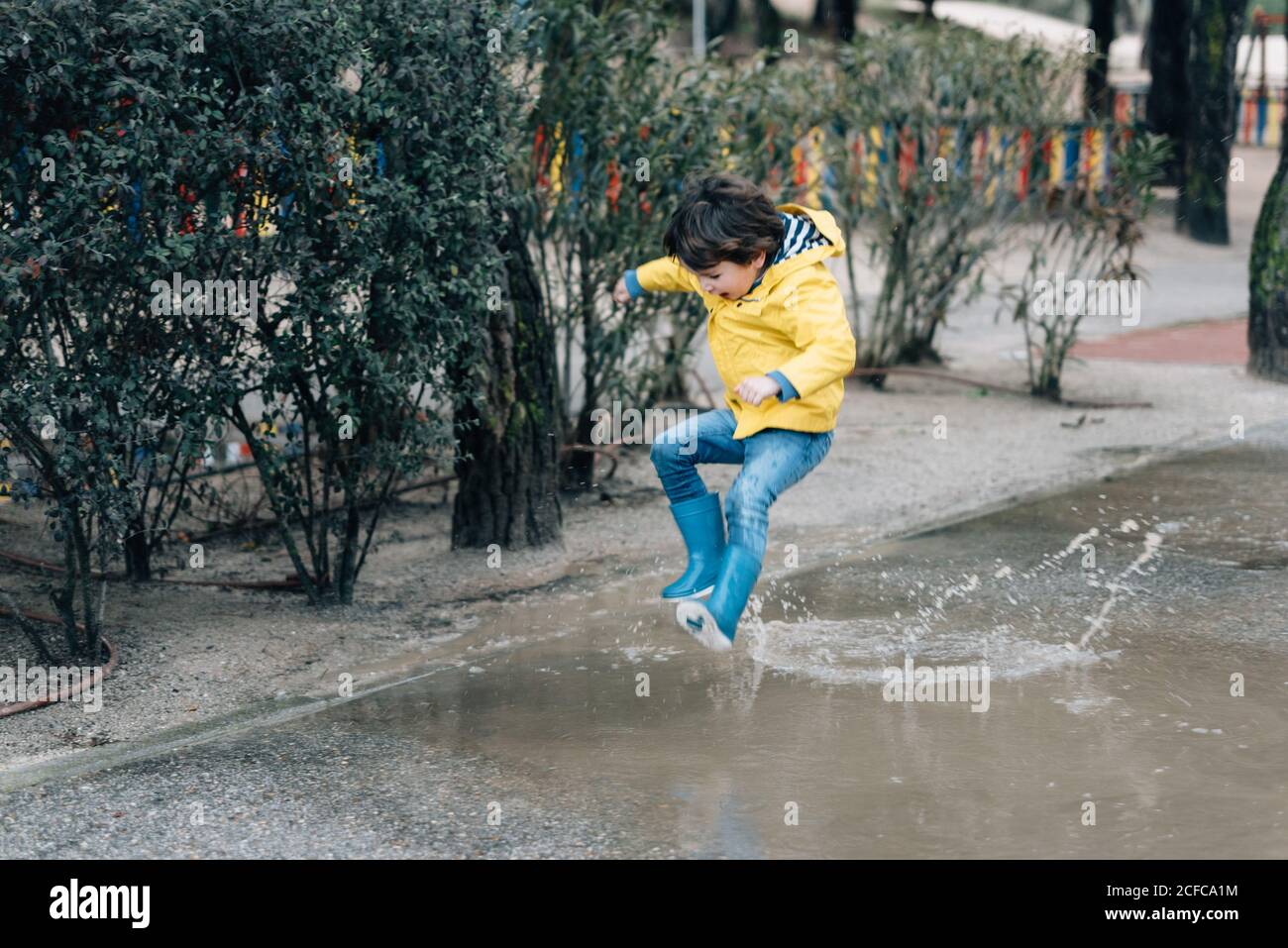 Boy jumping in puddle hi-res stock photography and images - Alamy