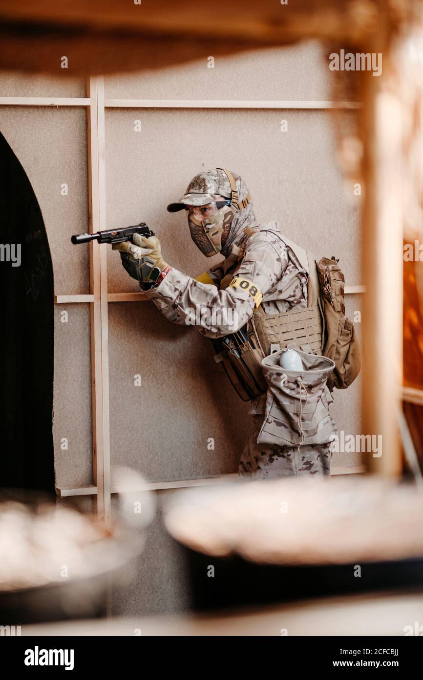 Soldier aiming airsoft gun during tactical game Stock Photo - Alamy