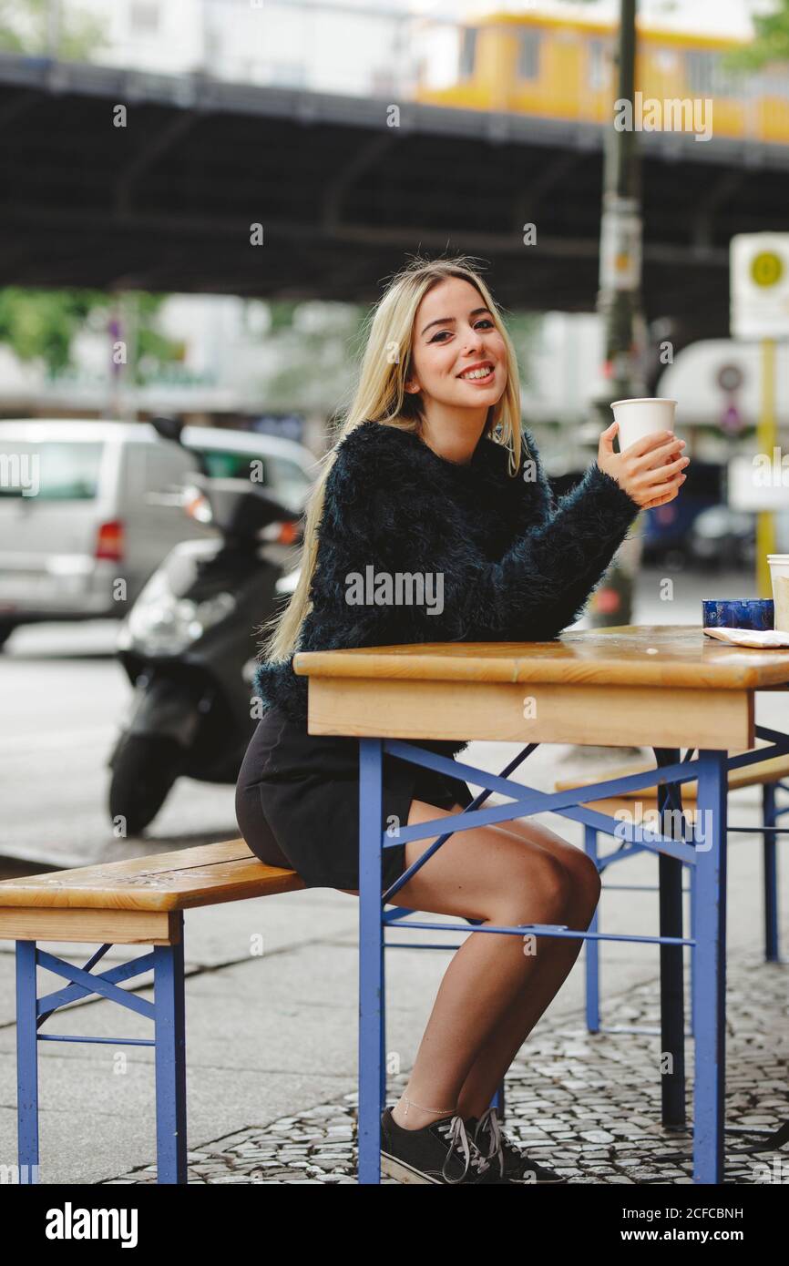 Beautiful cheerful Woman drinking coffee in Berlin street cafe on ...
