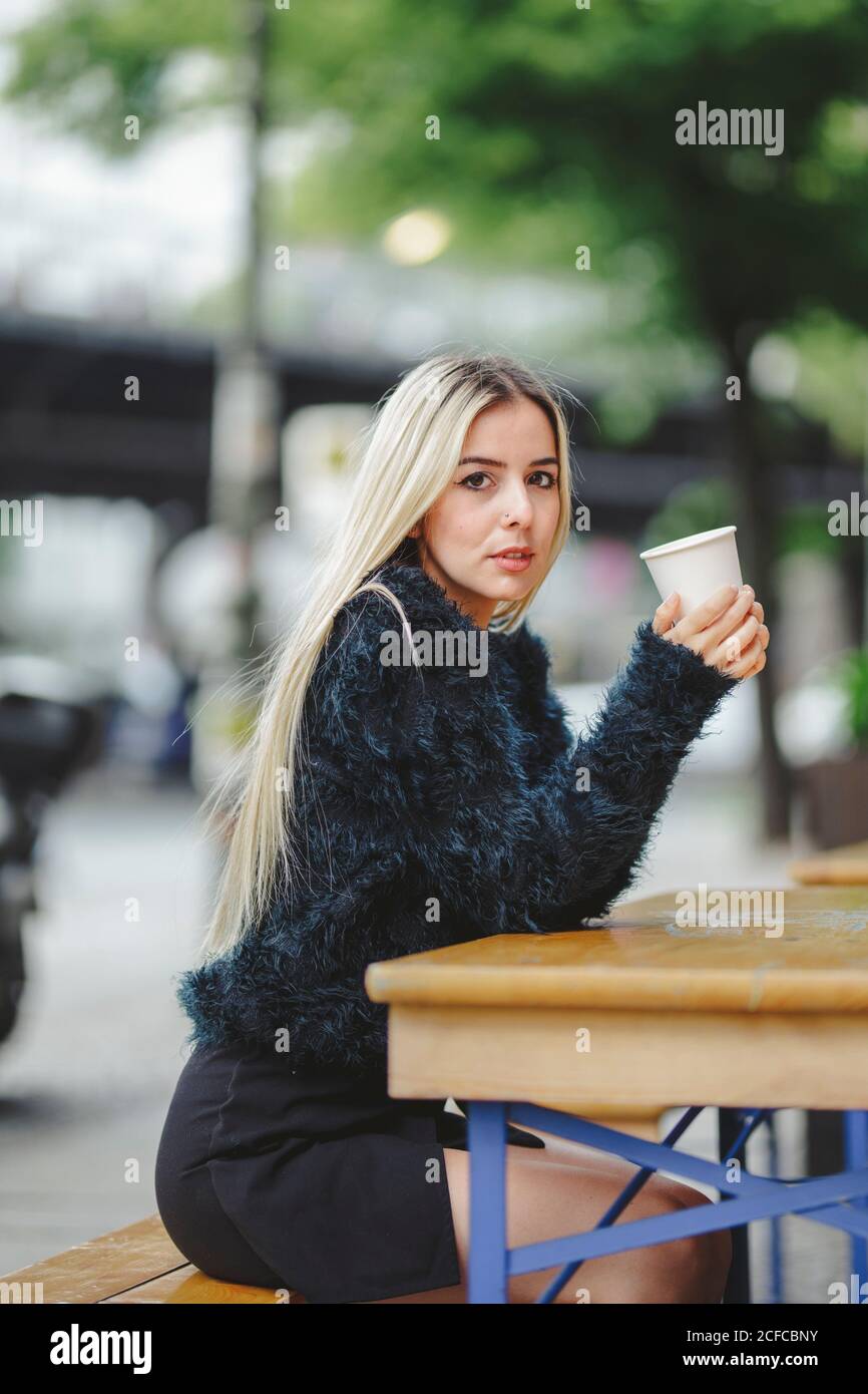 Beautiful cheerful Woman drinking coffee in Berlin street cafe on ...