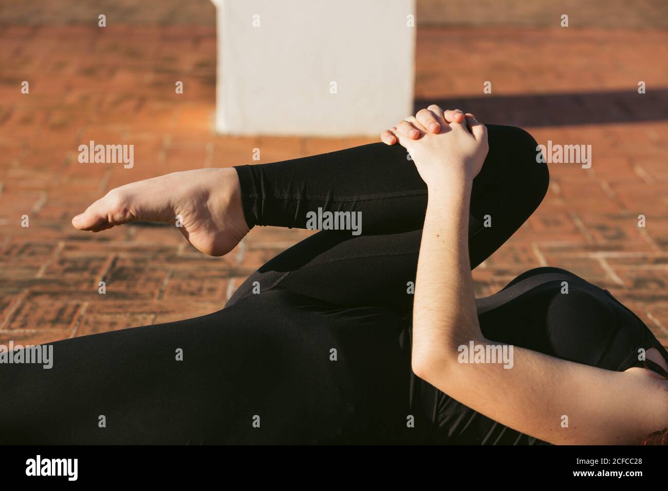 Women practicing supine yoga pose together Stock Photo - Alamy