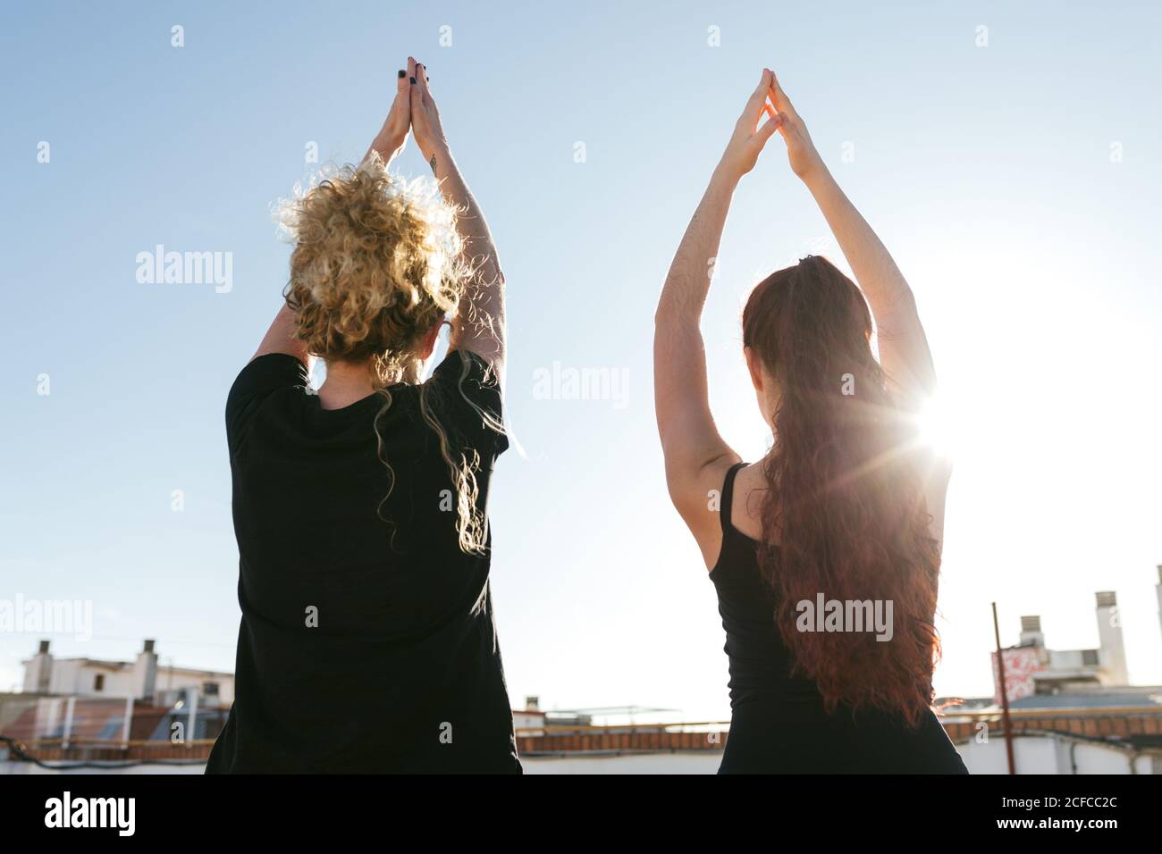 Women performing Sun Salutation during yoga practice Stock Photo - Alamy