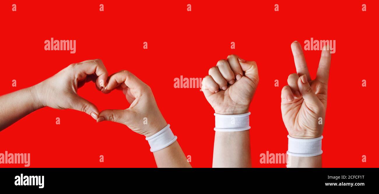 We believe, we can, we will win. Female hands with white bracelets on ...