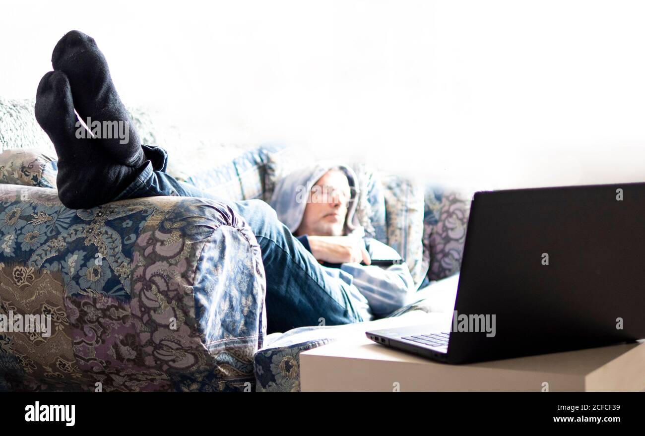 Man feet up sofa hi-res stock photography and images - Alamy