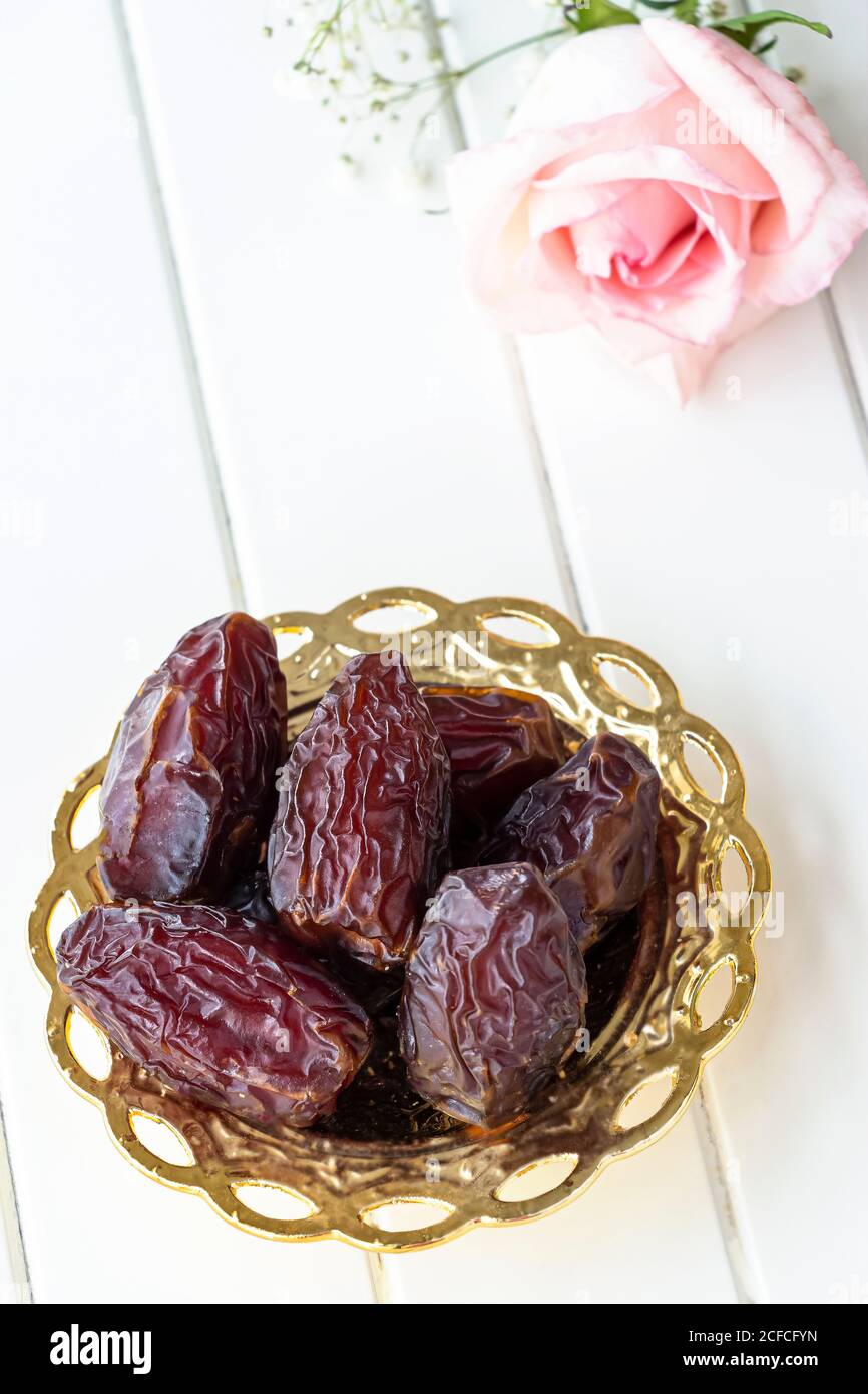 Organic dried dates in traditional arabic golden plate. Holy month ...