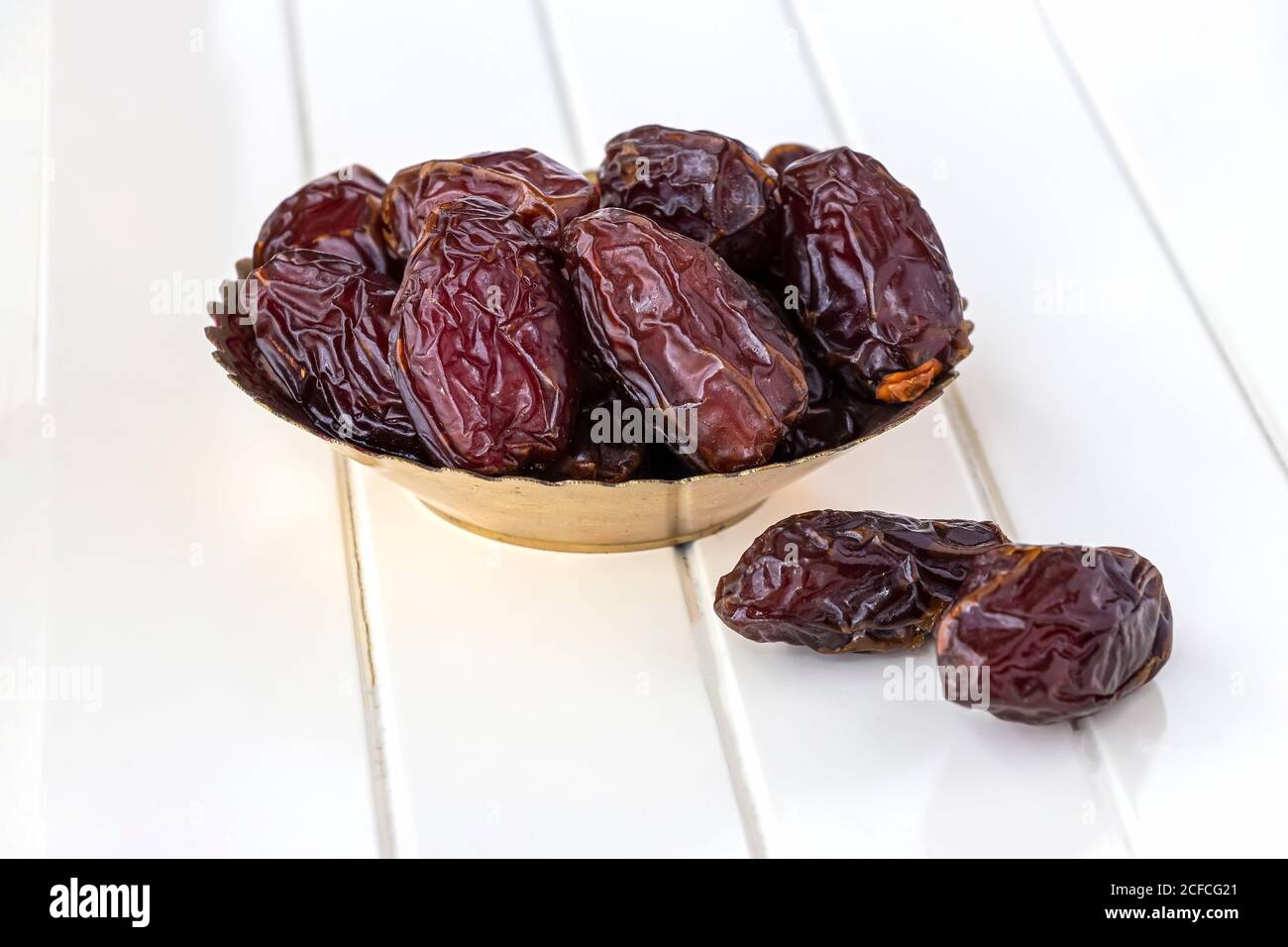 Organic dried dates in traditional arabic golden plate. Holy month ...