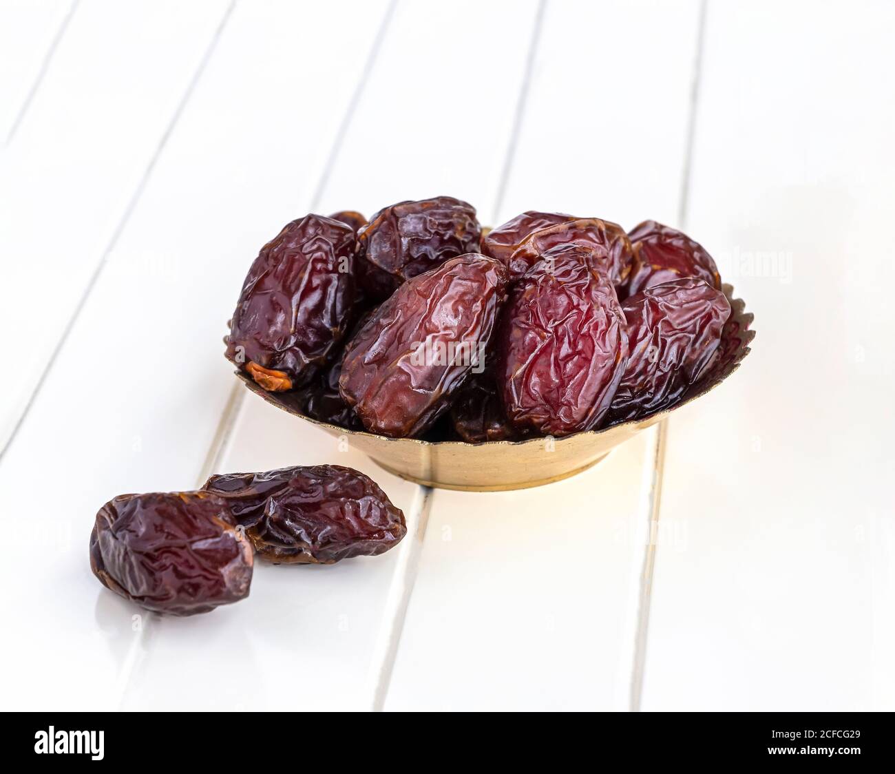 Organic dried dates in traditional arabic golden plate. Holy month ...
