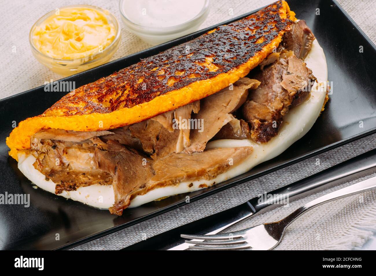 Cachapa, typical Venezuelan dish made with corn and stuffed with white ...