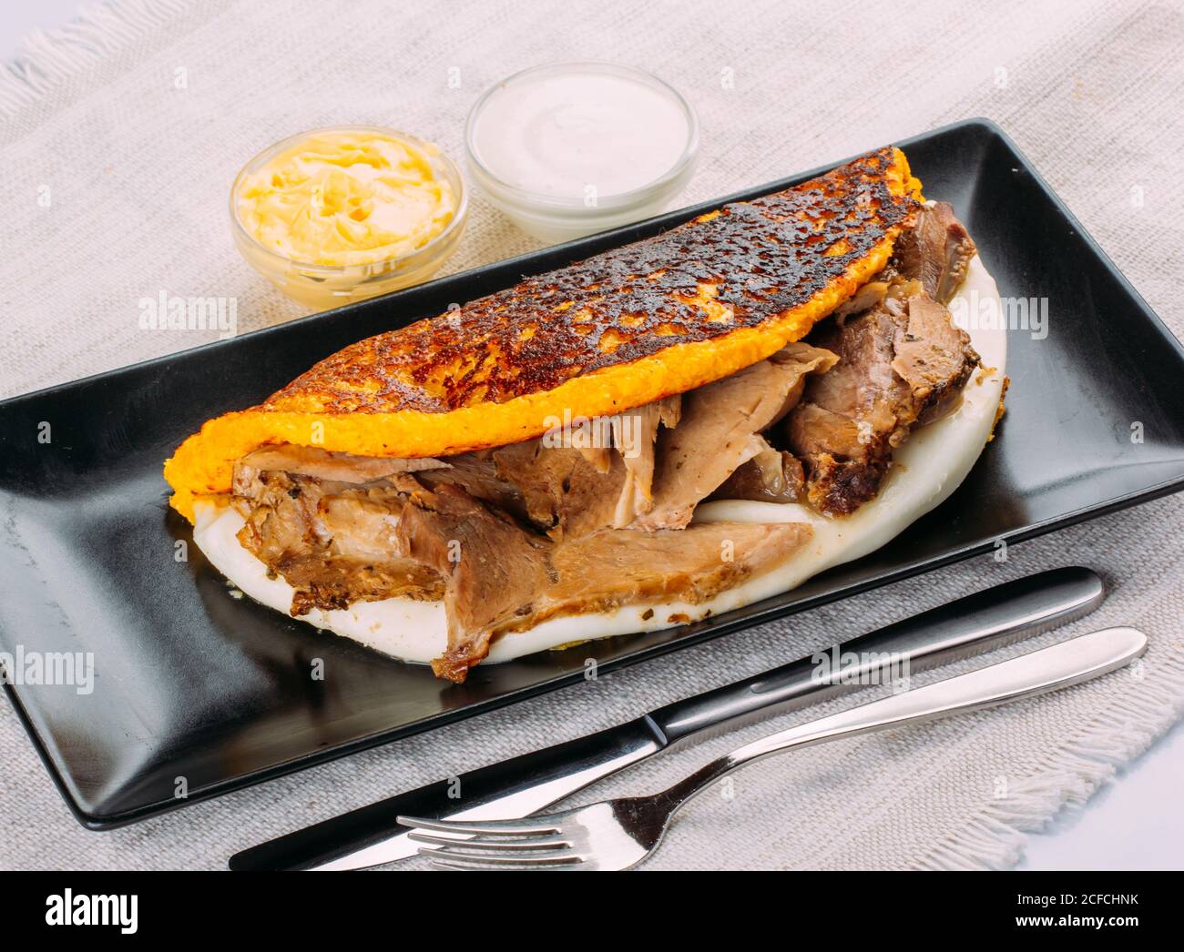 Cachapa, typical Venezuelan dish made with corn and stuffed with white ...