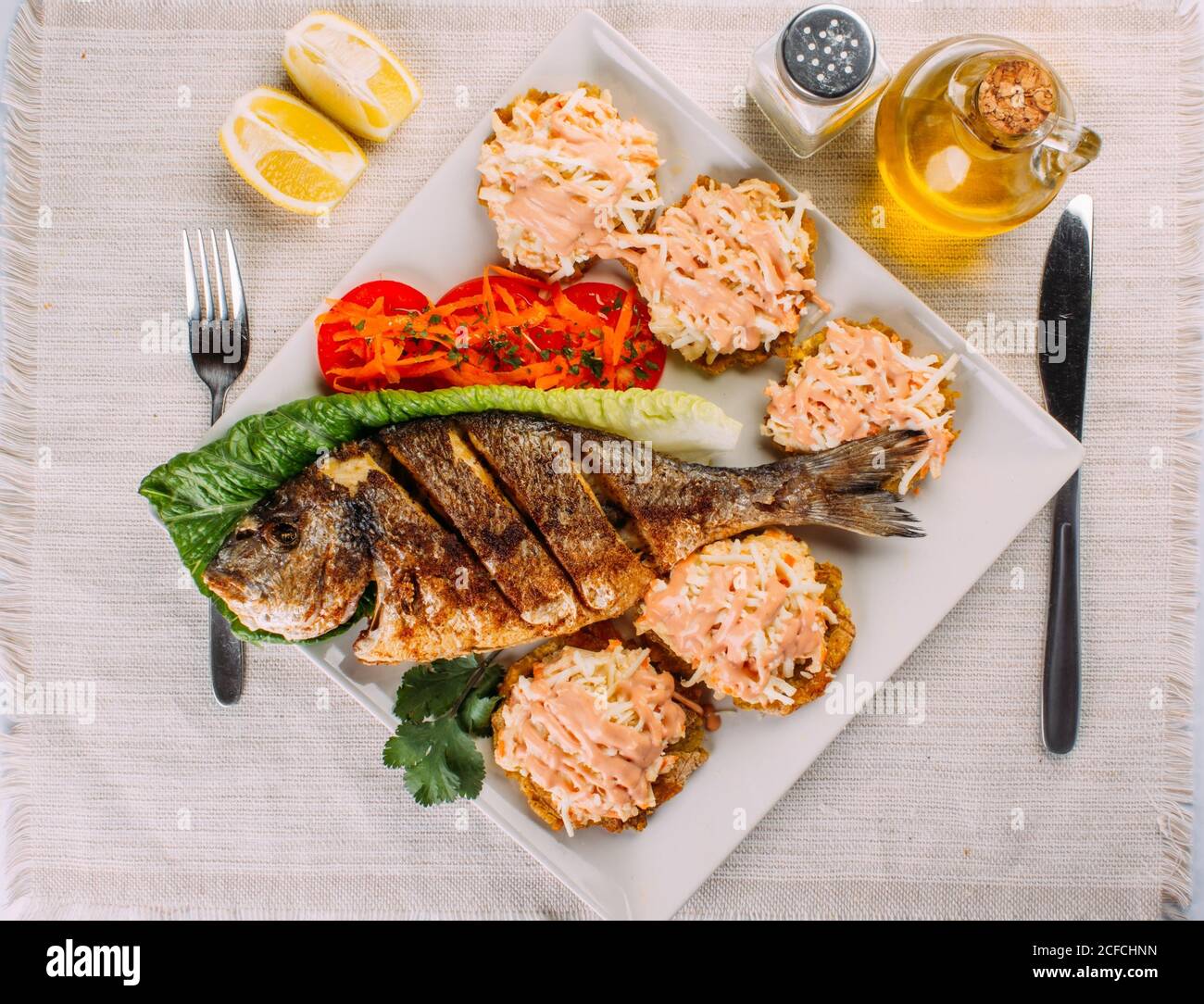 Top view of fried fish, salad and fried plantain Stock Photo - Alamy