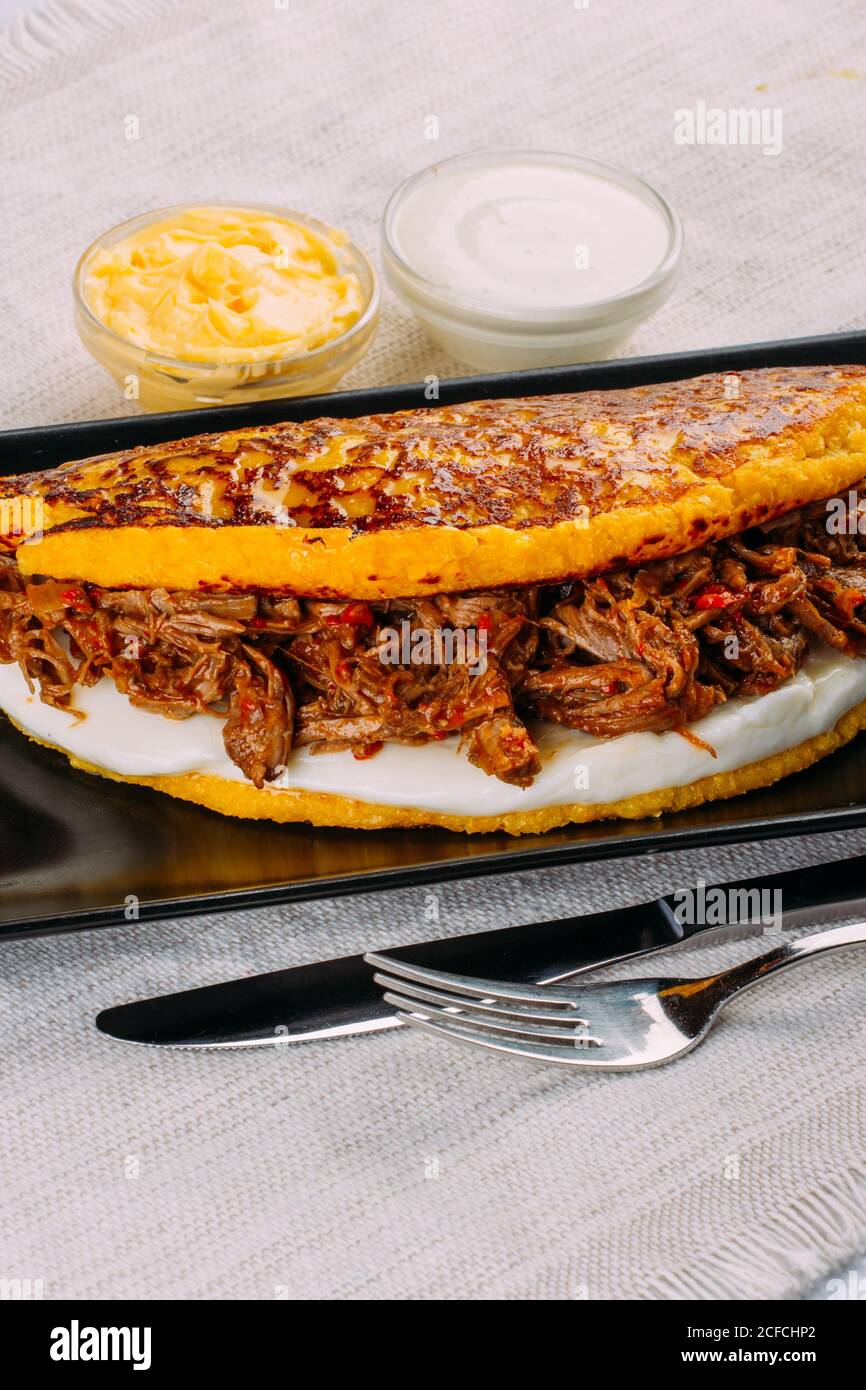 Cachapa, typical Venezuelan dish made with corn and stuffed with white ...