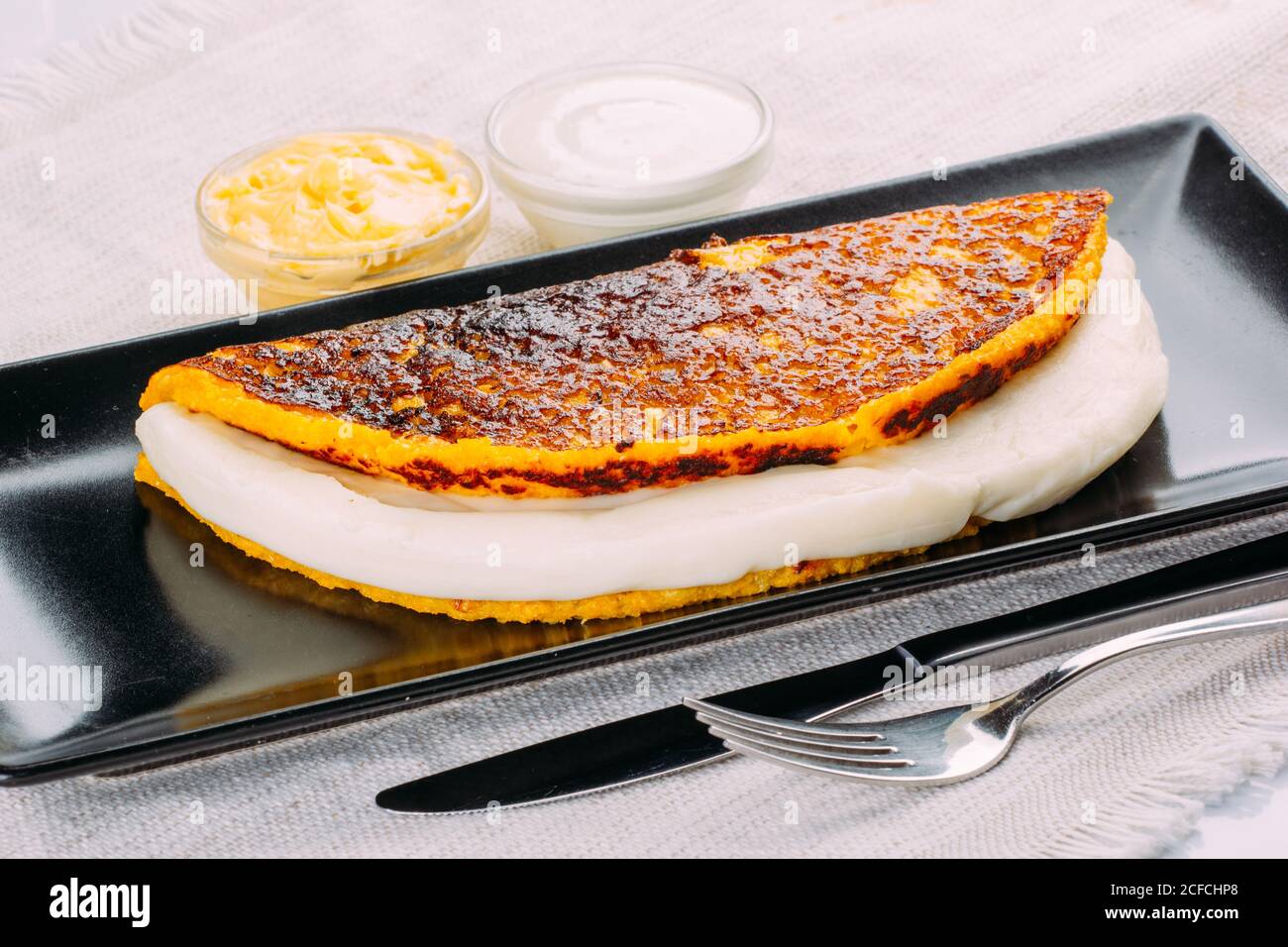 Cachapa, typical Venezuelan dish made with corn and stuffed with white ...