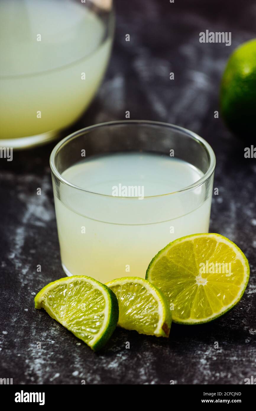 From above homemade refreshing lemonade in server in glasses on black ...