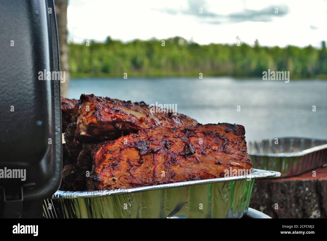 Delicious looking ribs on the grill next to a lake Stock Photo - Alamy