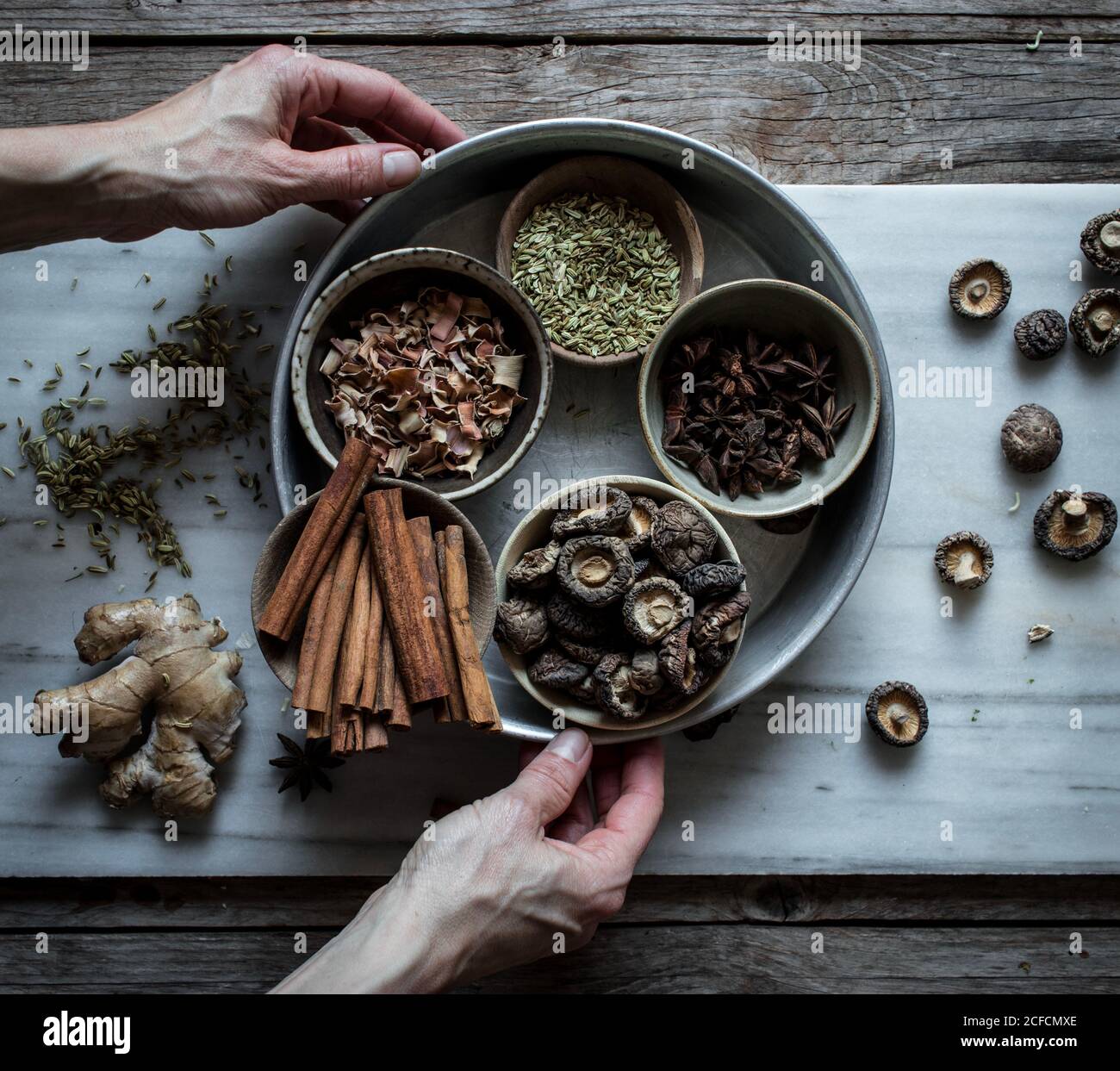 Top view of unrecognizable person hands holding mixed dry spices and ...