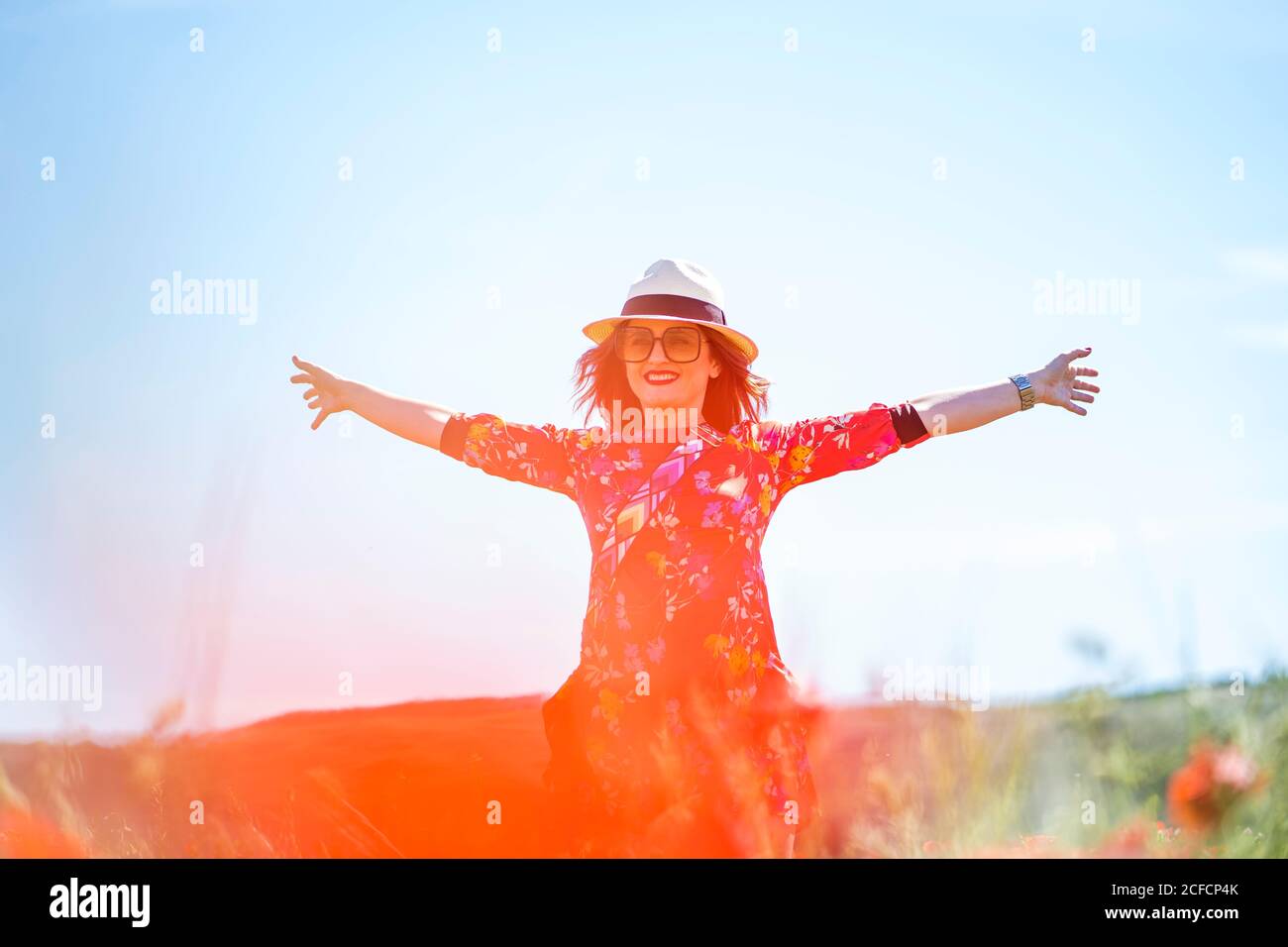 Lady standing in field Stock Photo - Alamy