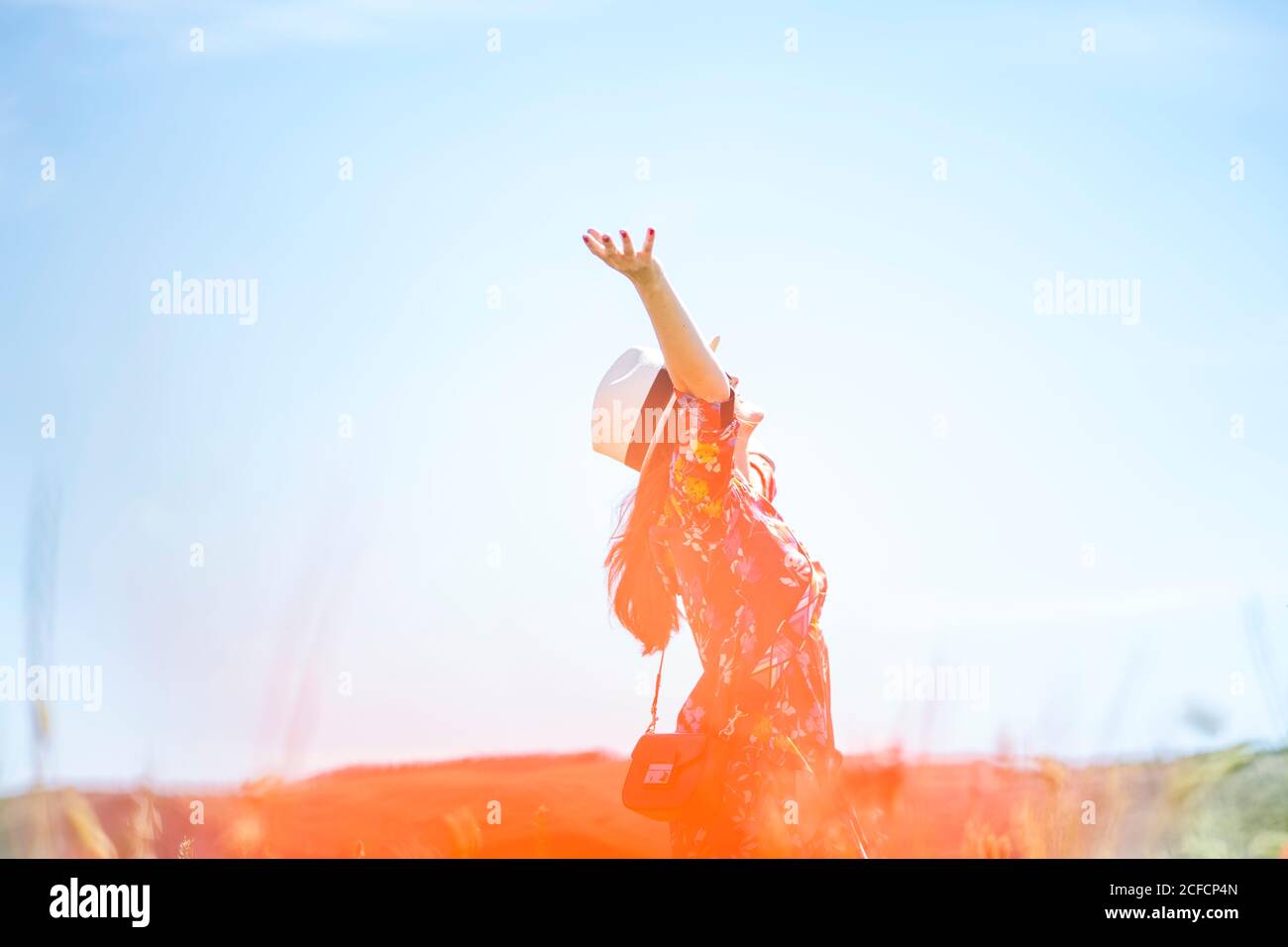 Lady standing in field Stock Photo - Alamy