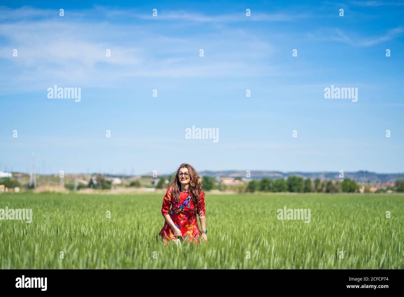 Lady standing in field Stock Photo - Alamy