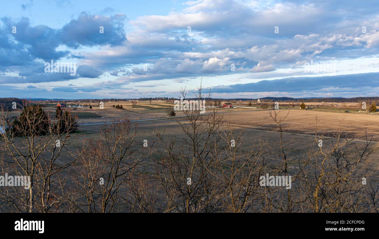 Puffy clouds hang in a blue sky over Gettysburg National Battlefield ...