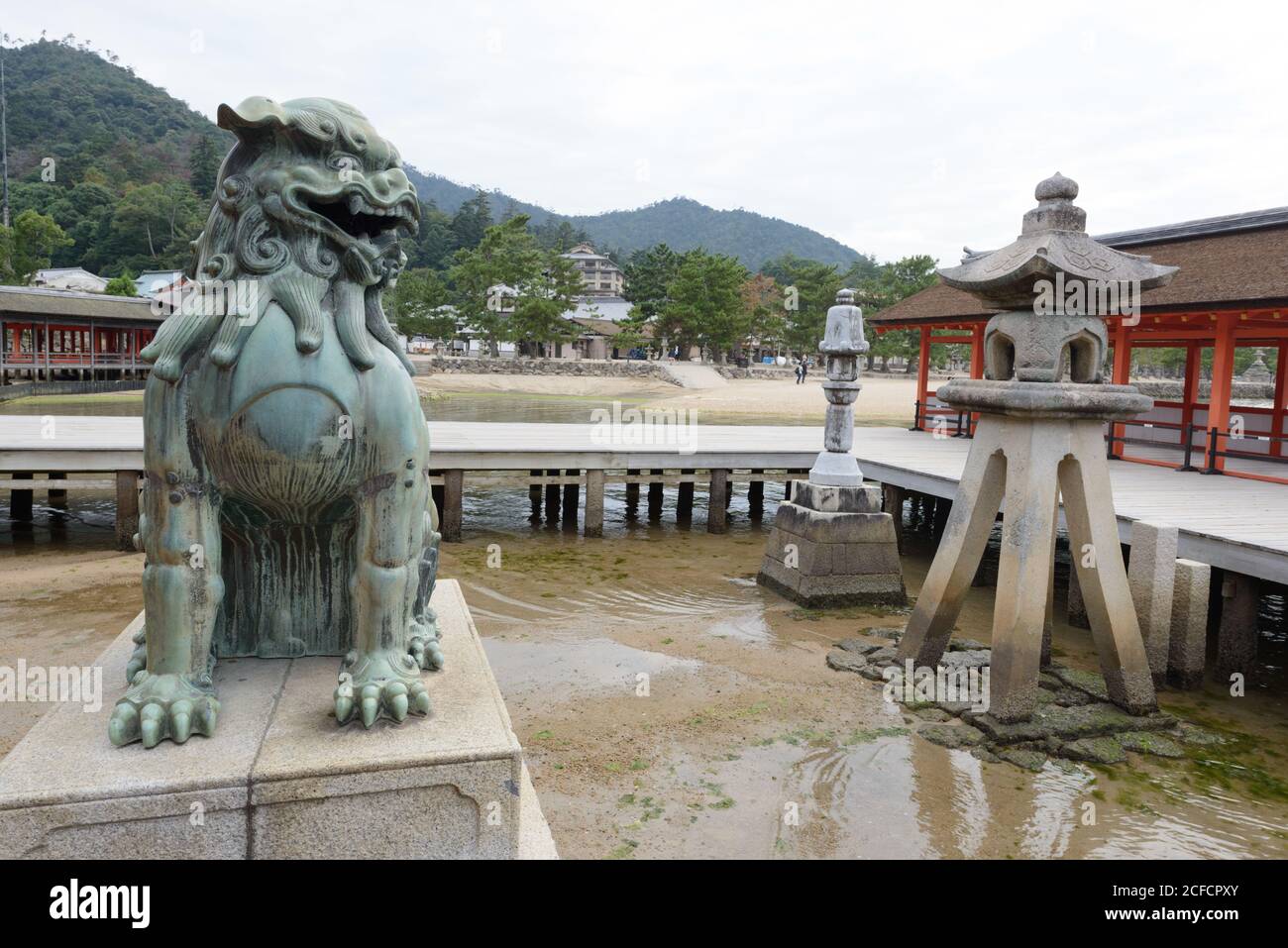 Bronze statue of traditional guardian lion dog located in Shinto shrine ...