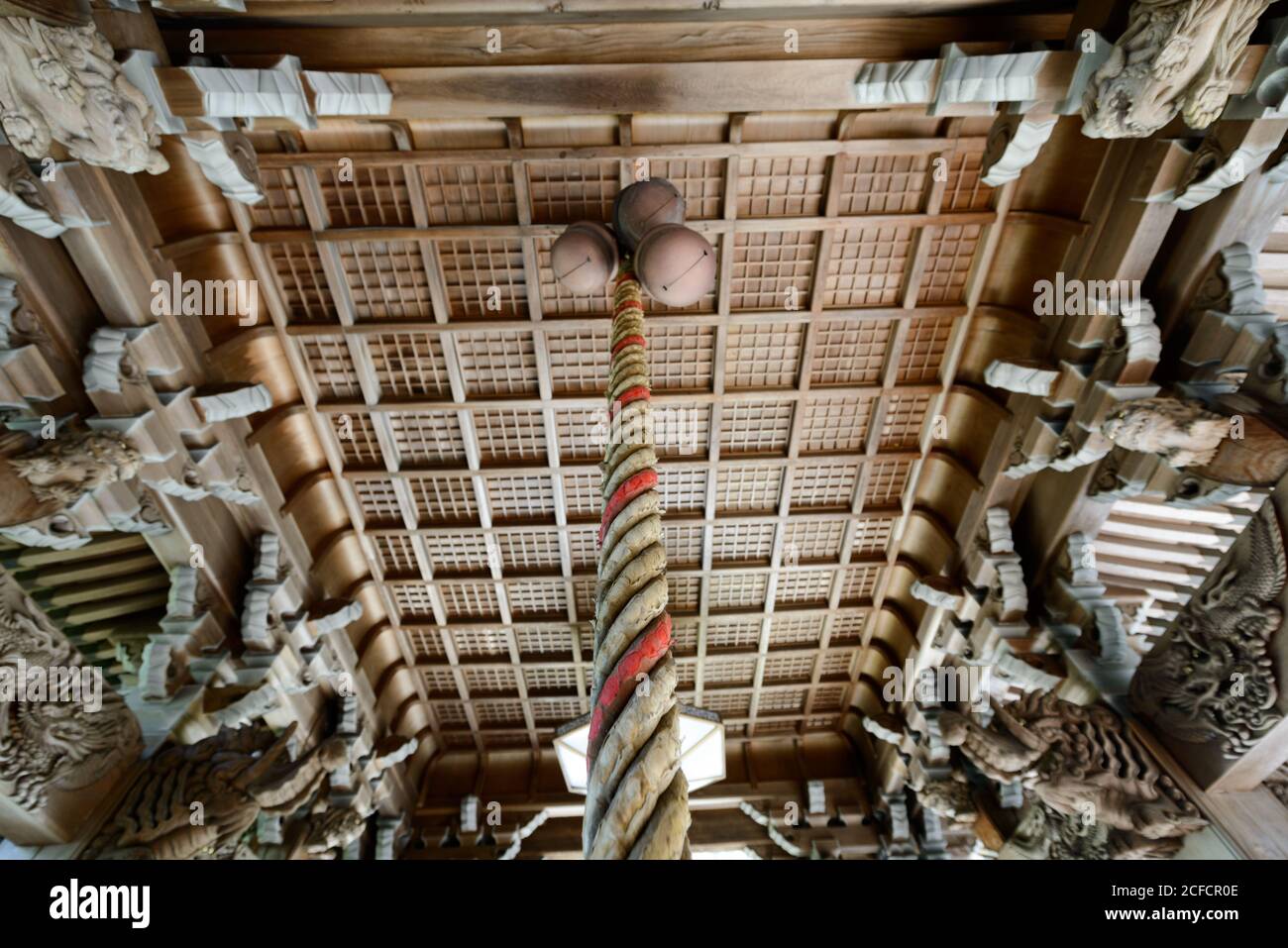 From below of wooden ceiling with decorative elements and figures in ...