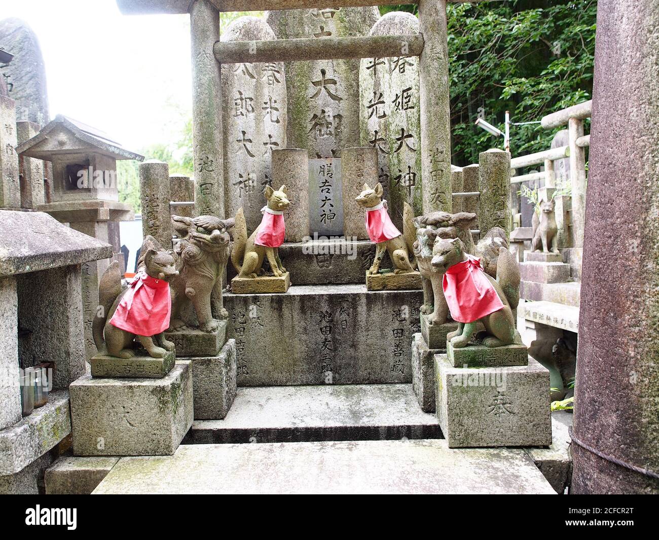 Shabby fox and dog sculptures located near ancient monument in yard of ...