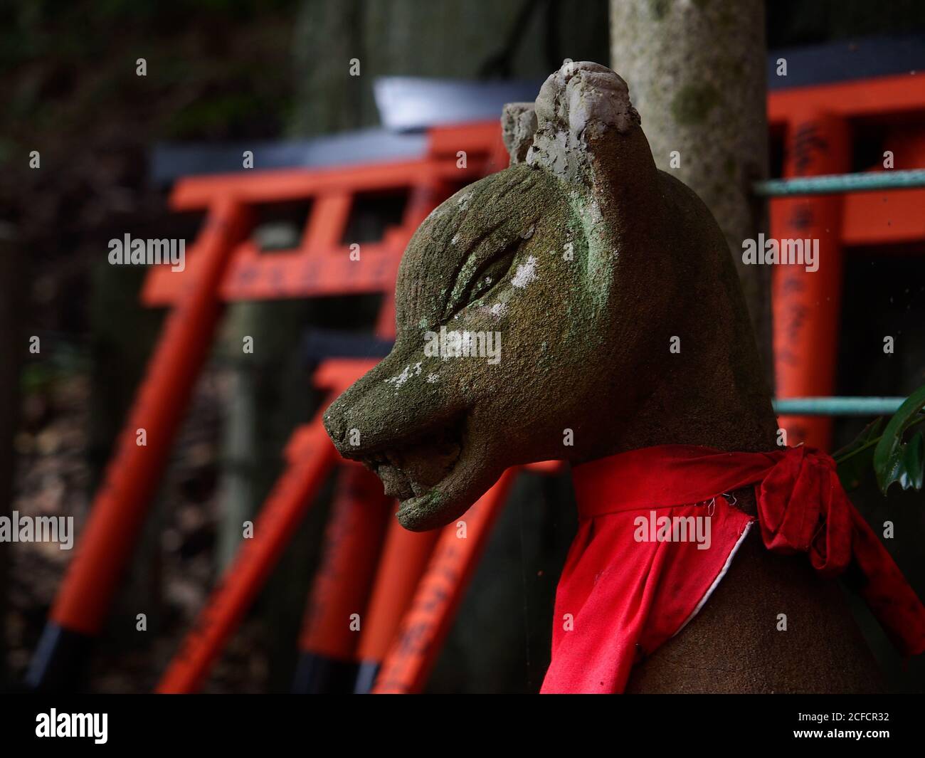 Shabby sculpture of fox spirit located outside traditional Shinto ...