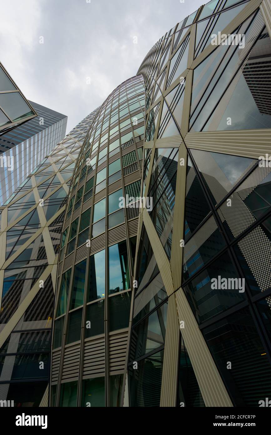 Modern glass tower under cloudy sky Stock Photo - Alamy