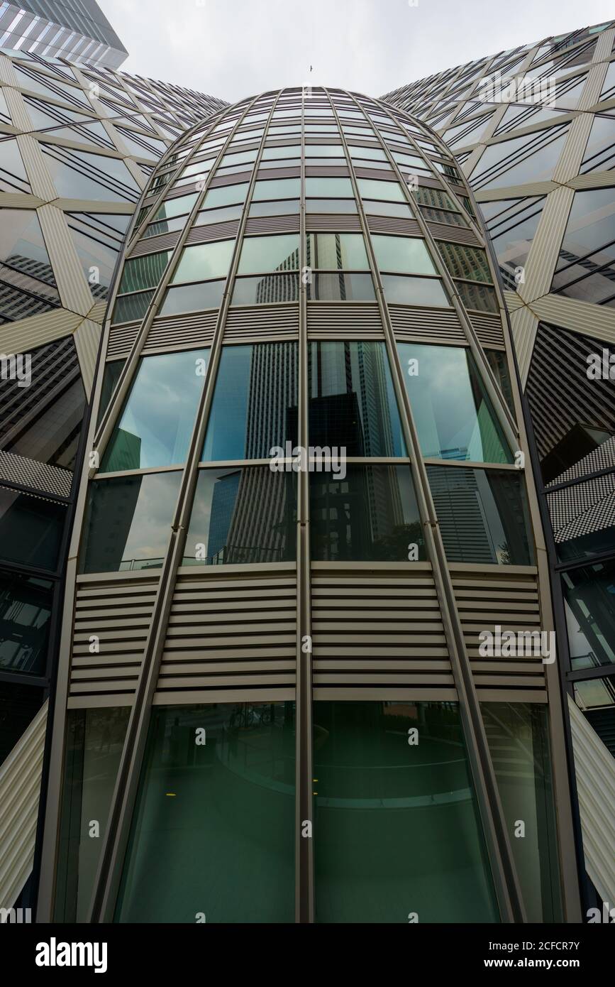 Modern glass tower under cloudy sky Stock Photo - Alamy