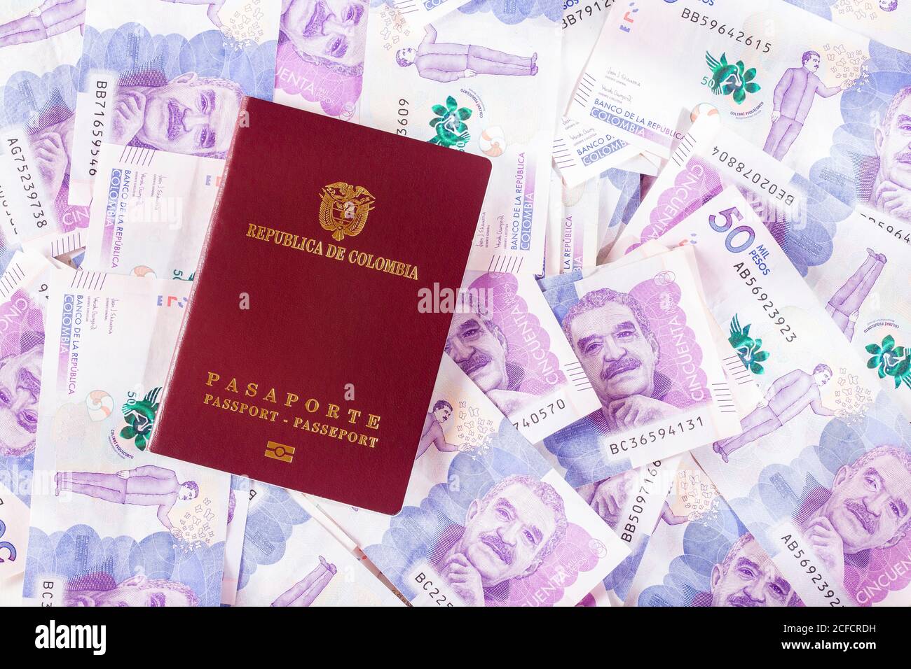 Colombian passport on Colombian money, close-up image Stock Photo - Alamy