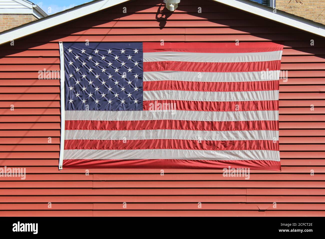 The American Flag on display of the wall of a garage Stock Photo - Alamy