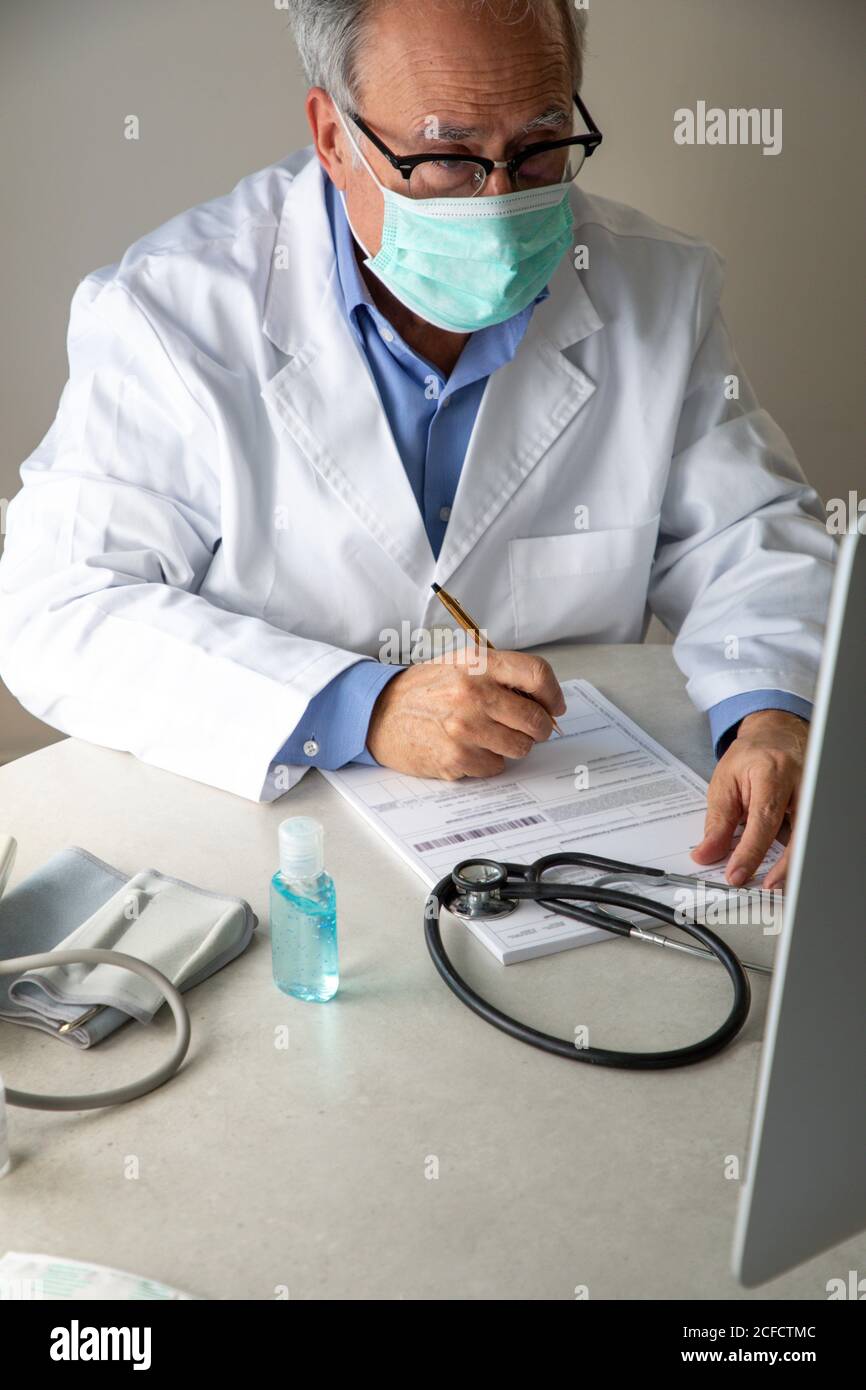 Doctor taking notes mask hi-res stock photography and images - Alamy