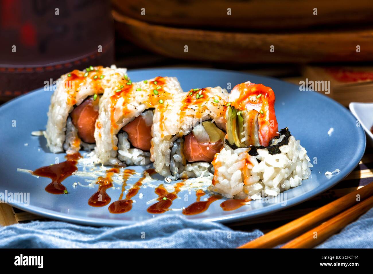 Appetizing delicious colorful sushi with red sauce and green at served ...