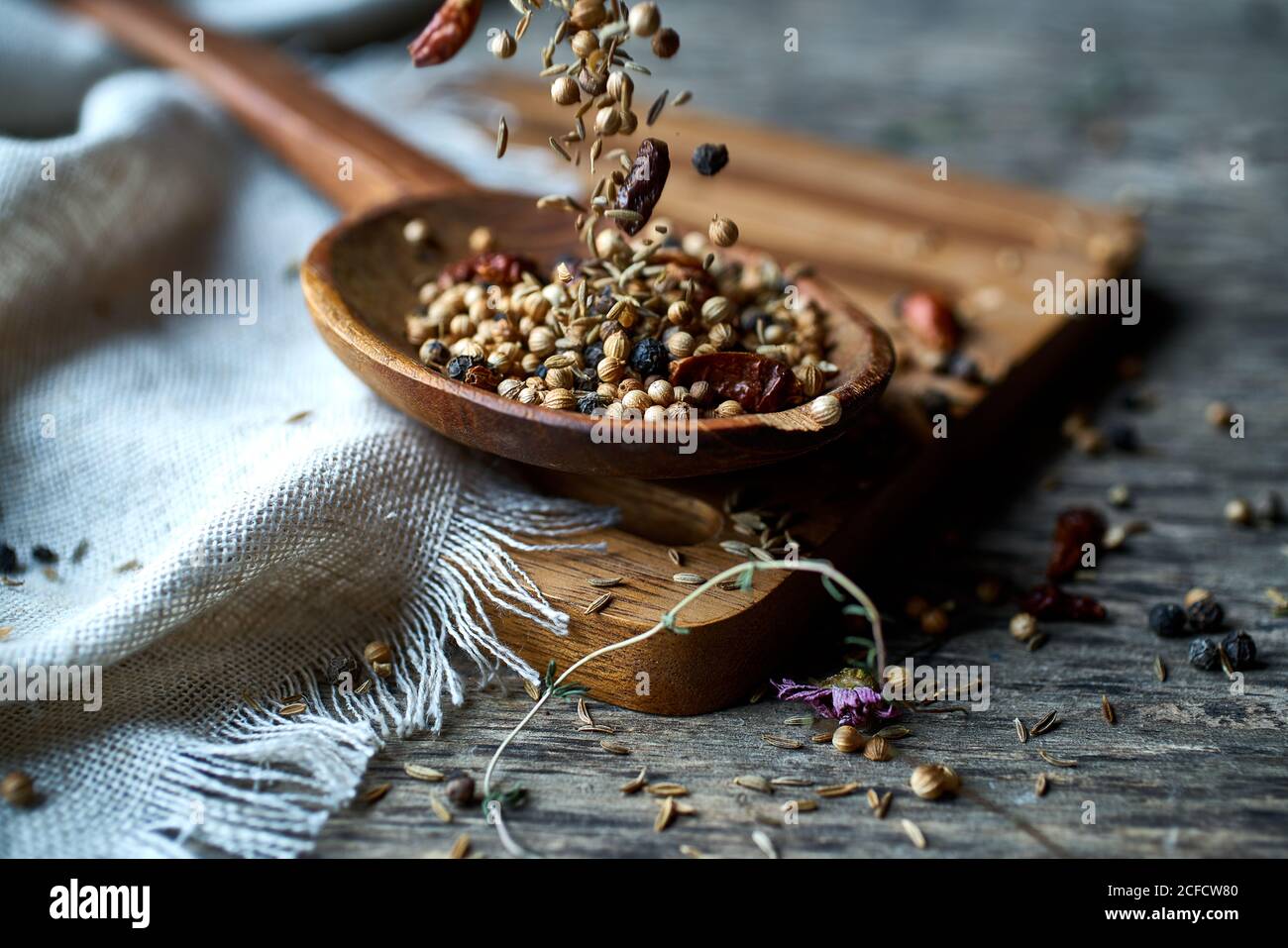Dry mix of spices and dried berries in spoon on table Stock Photo - Alamy