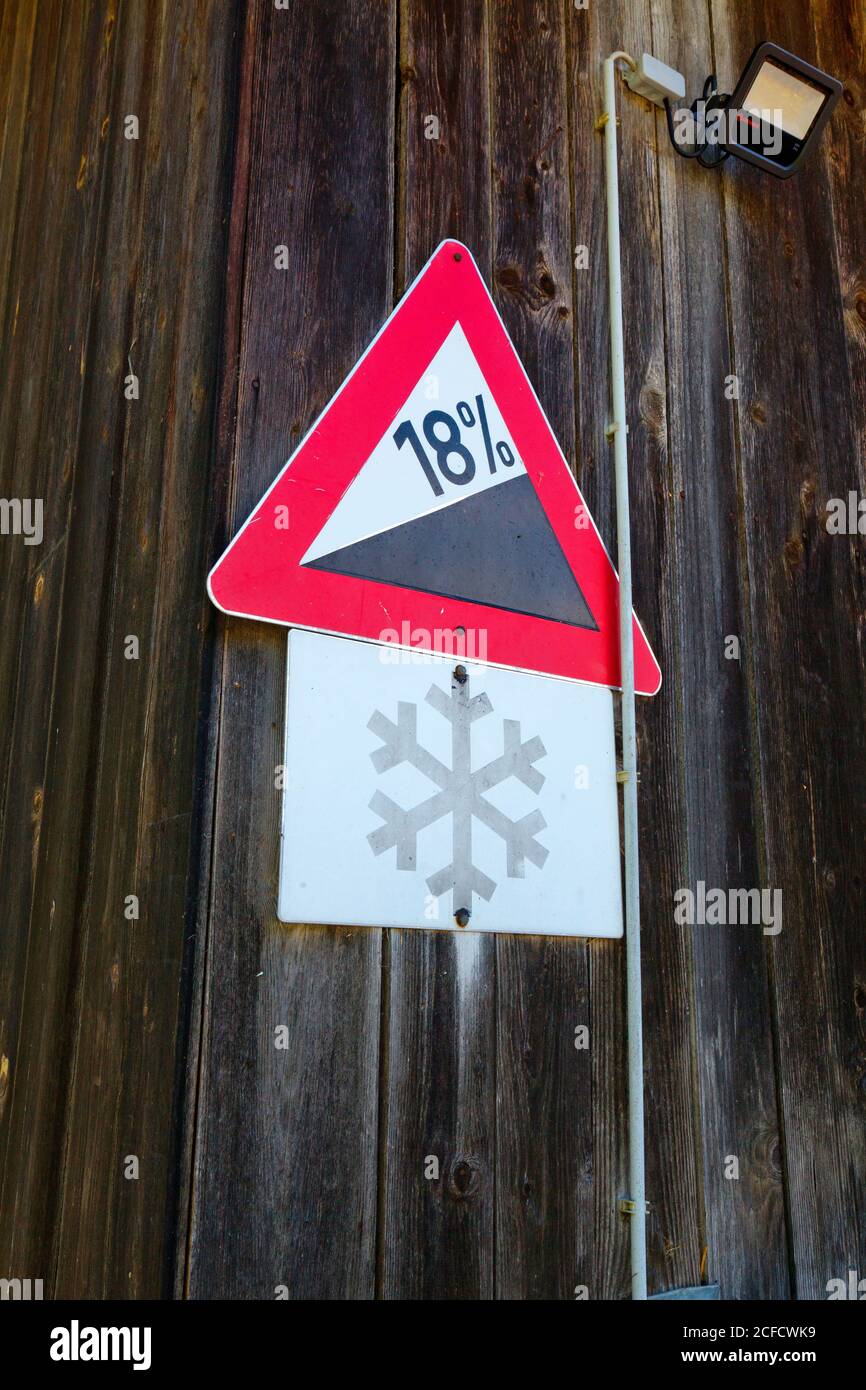 Road sign for 18 percent gradient and danger from snow Stock Photo - Alamy