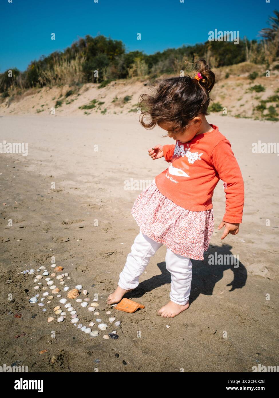 Girl playing with shells hi-res stock photography and images - Alamy