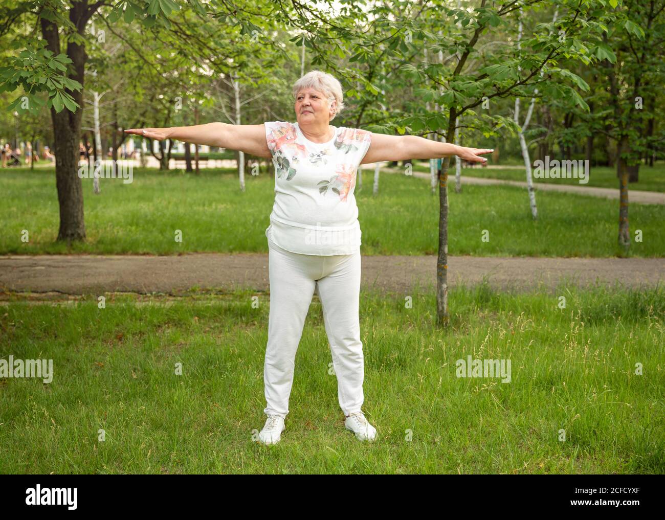 Optimistic old woman exercising for healthy life in open air. Wellness ...