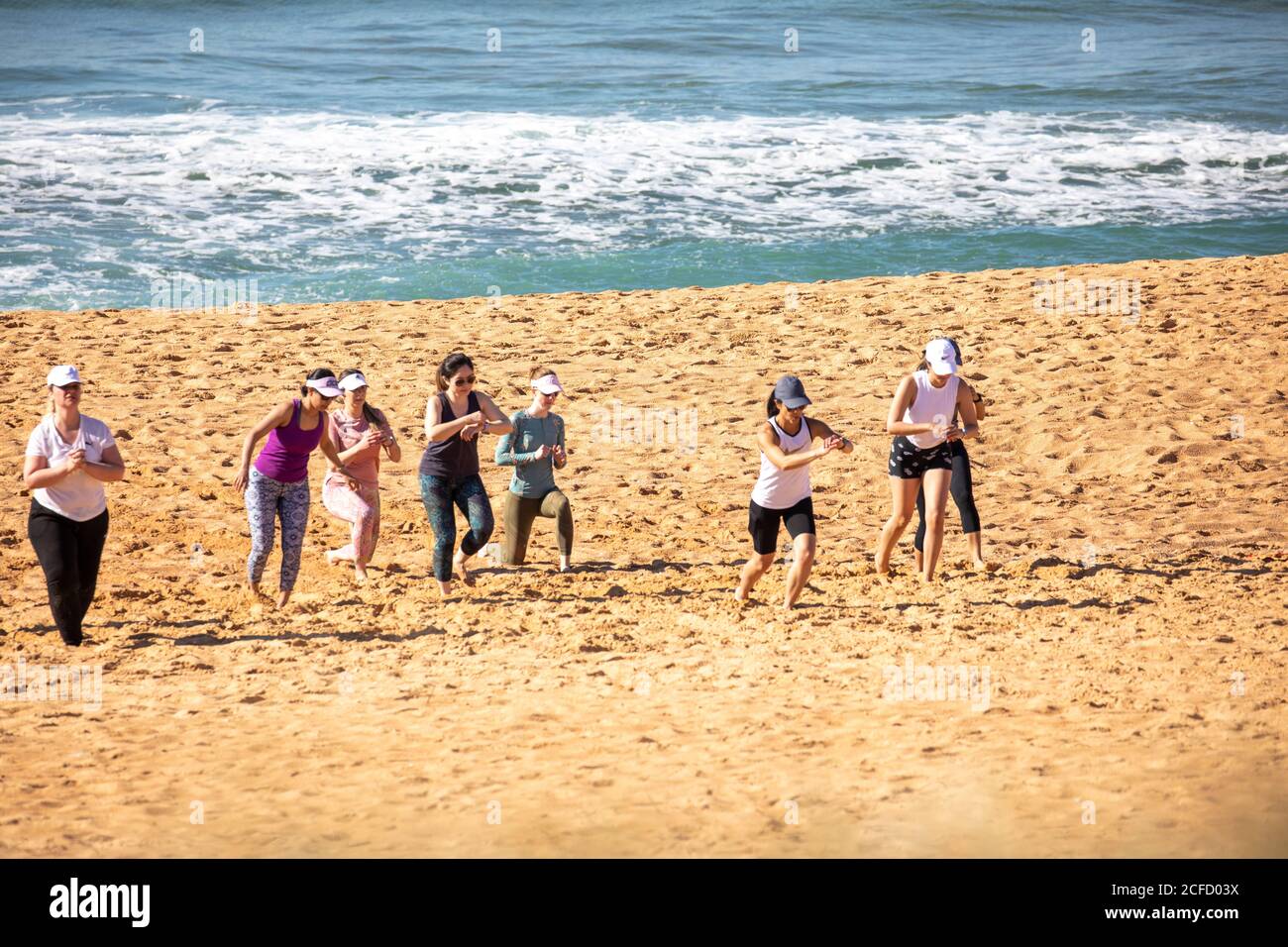 Australian women exercise and keeping fit weight loss on a beach in ...