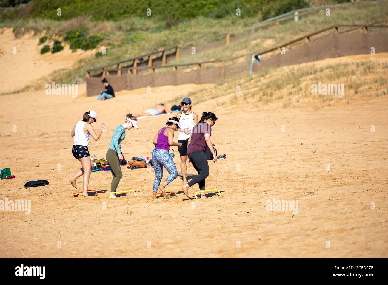Sydney beach, group of australian women exercising and stretching on a ...