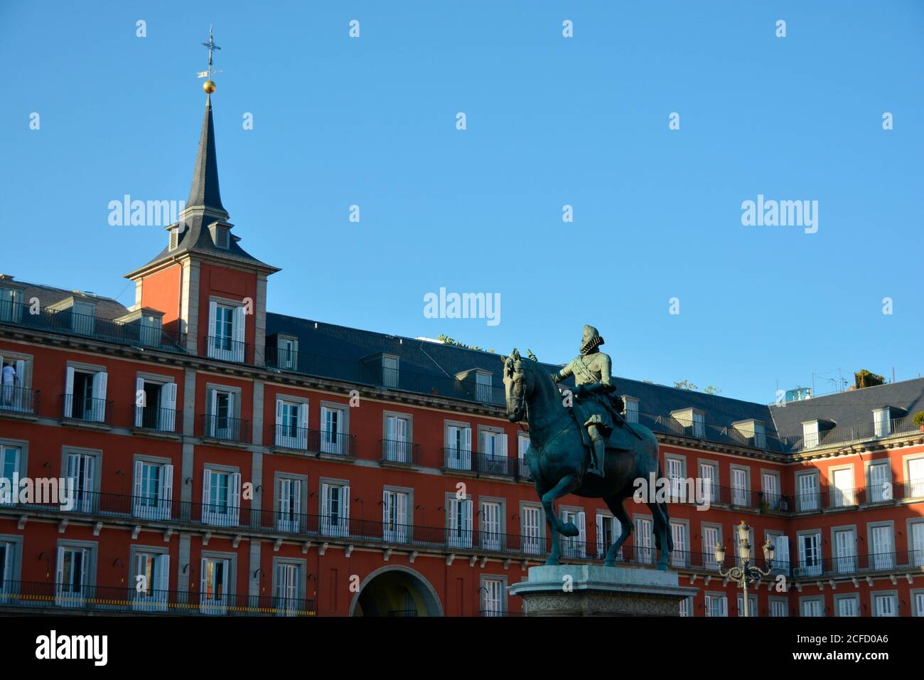 Government buildings painted red surround Madrid's main city plaza ...