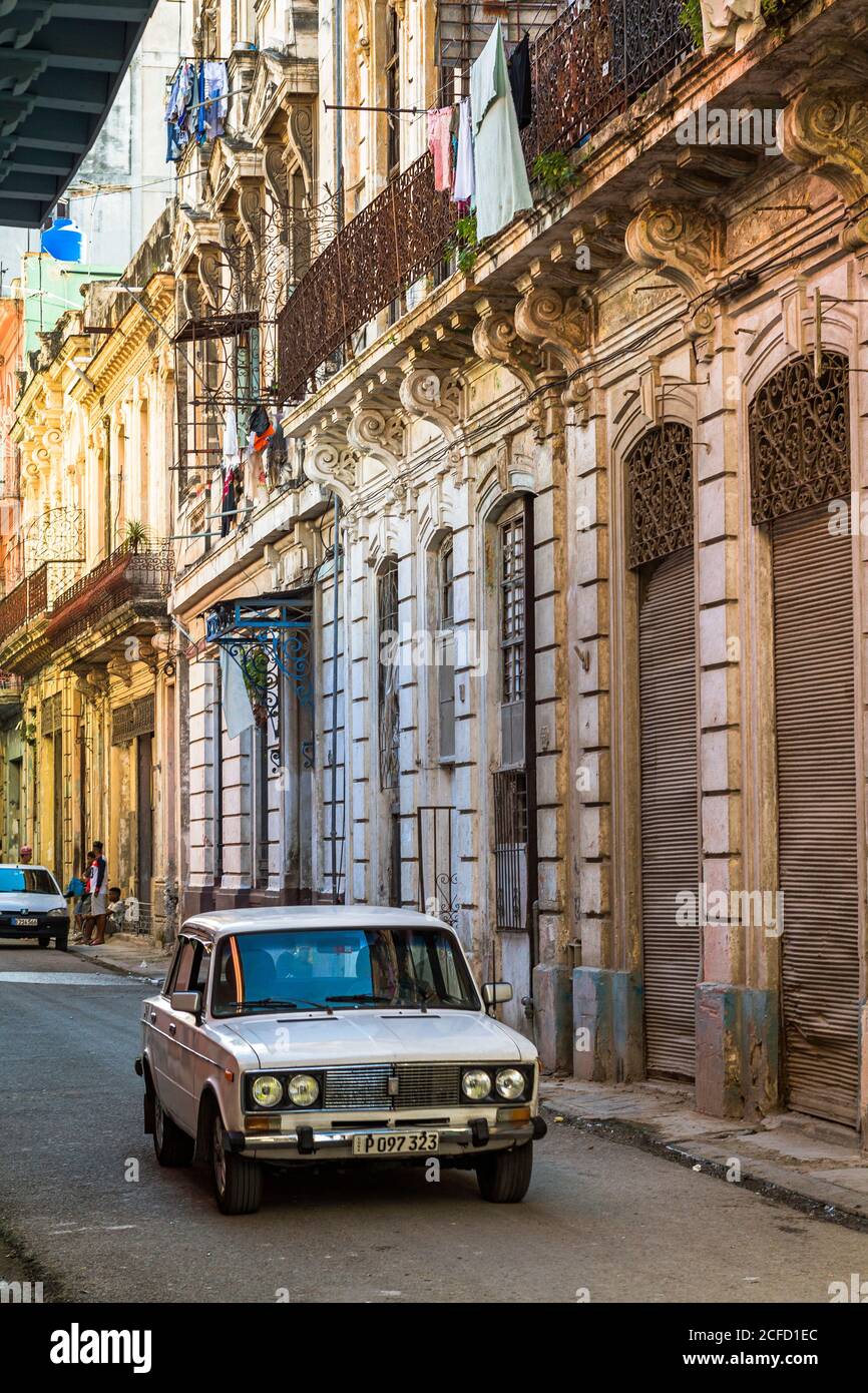 Colorful Cuban alley with old colonial house facades and old car, Old ...