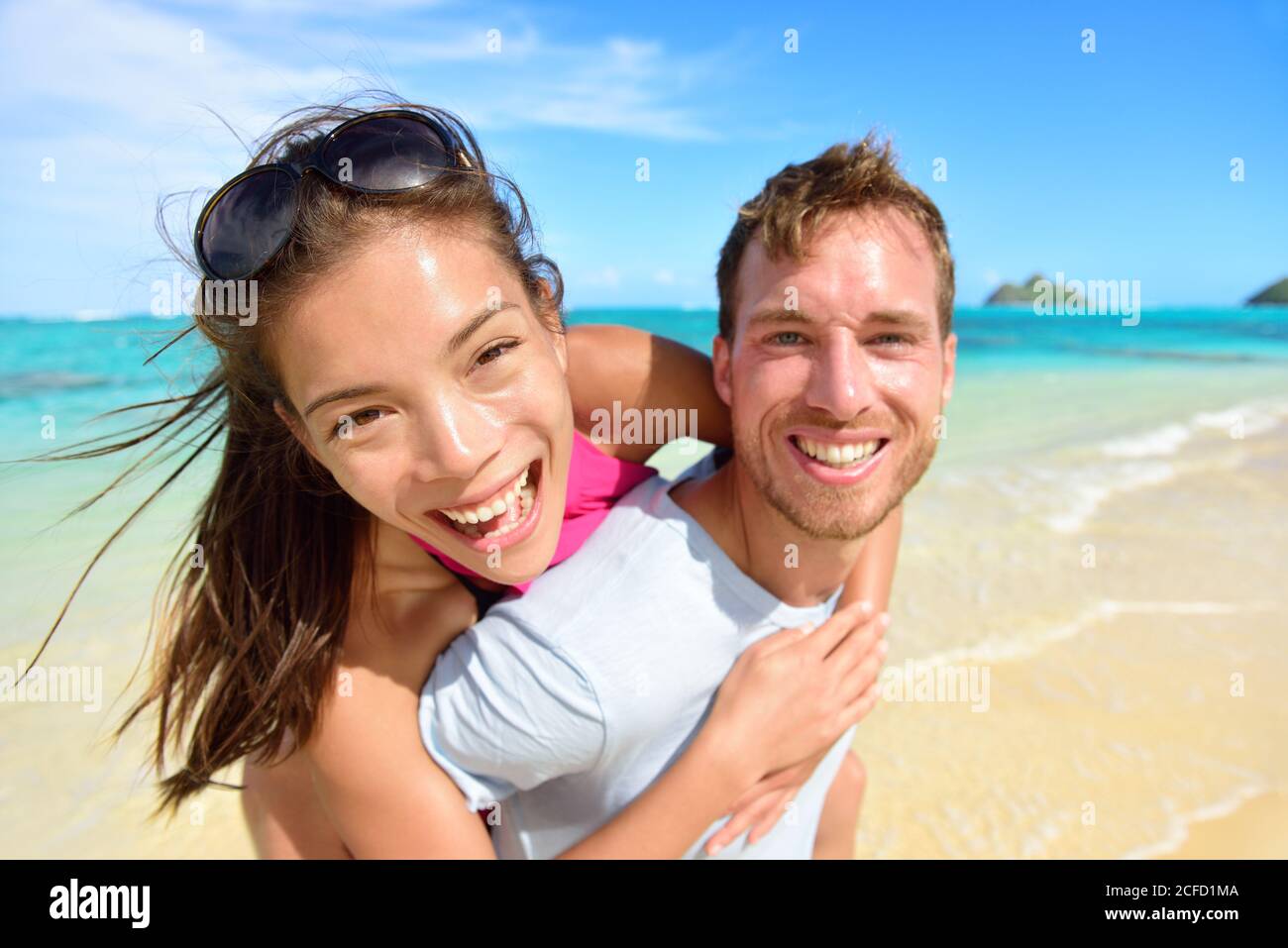 Happy couples on beach hi-res stock photography and images - Alamy