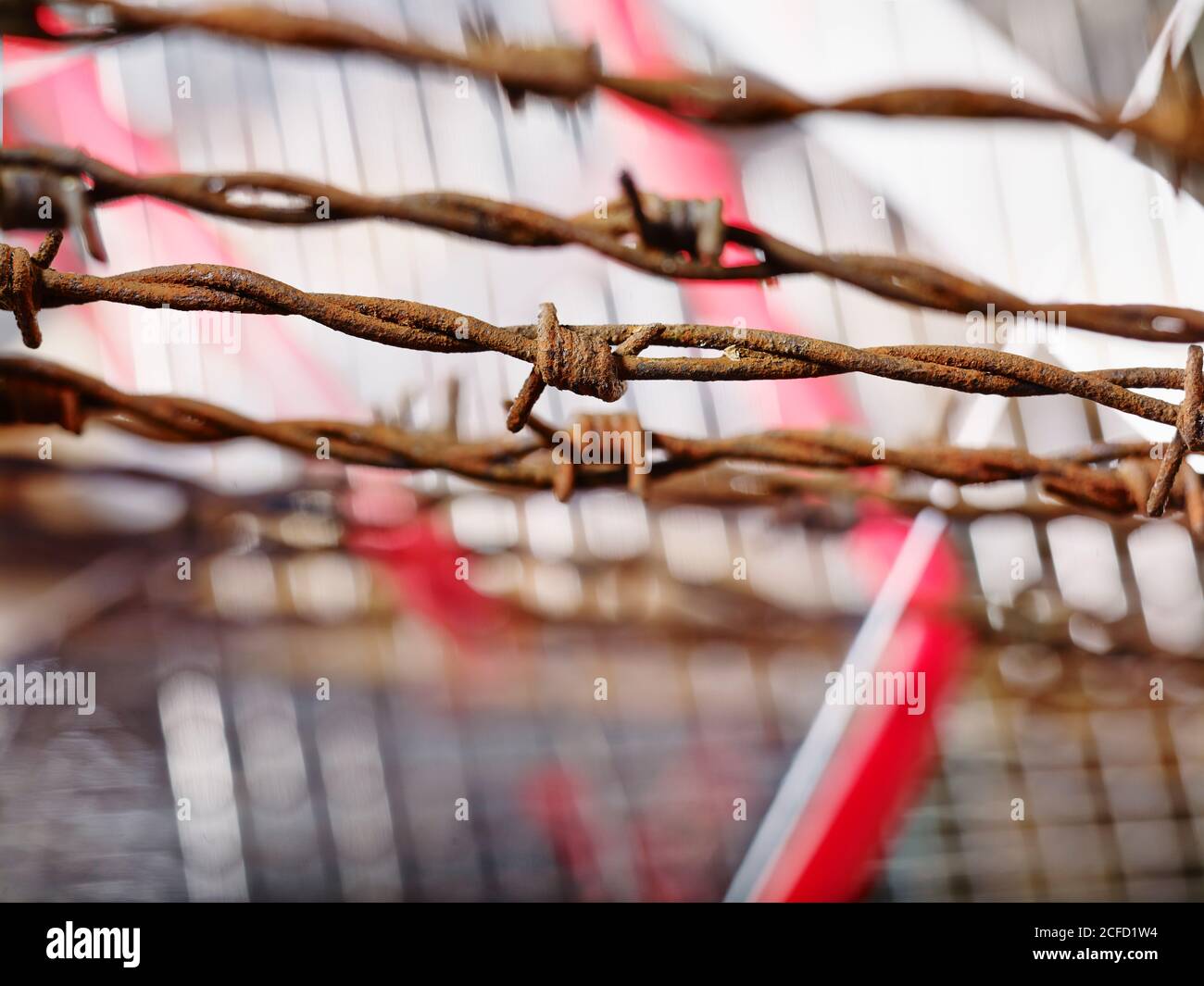 Icon image, barrier, barbed wire and ribbon, close-up of rusted barbed ...