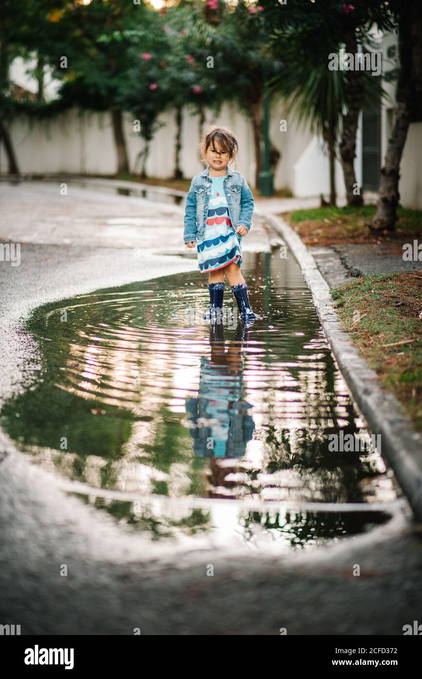 Toddler playing in mud puddle hi-res stock photography and images - Alamy