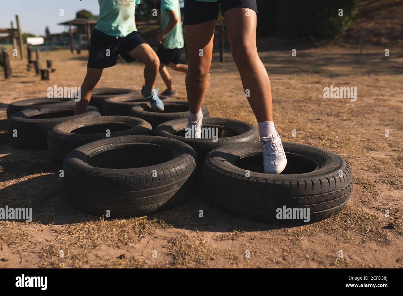 Mid section of kids walking through tires at a boot camp Stock Photo ...