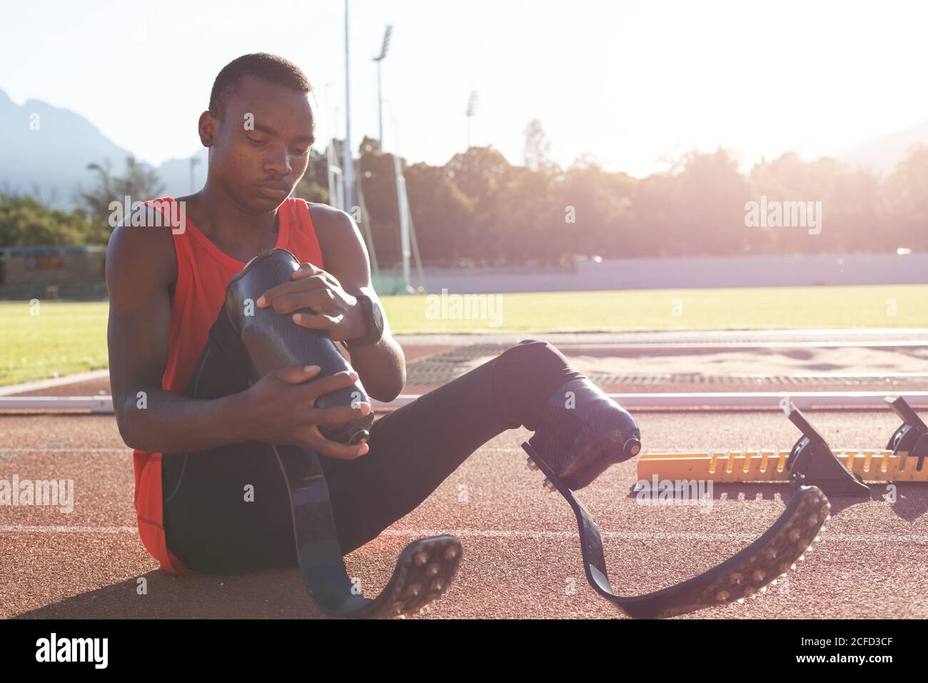 Male athlete wearing prosthetic leg on race track Stock Photo - Alamy