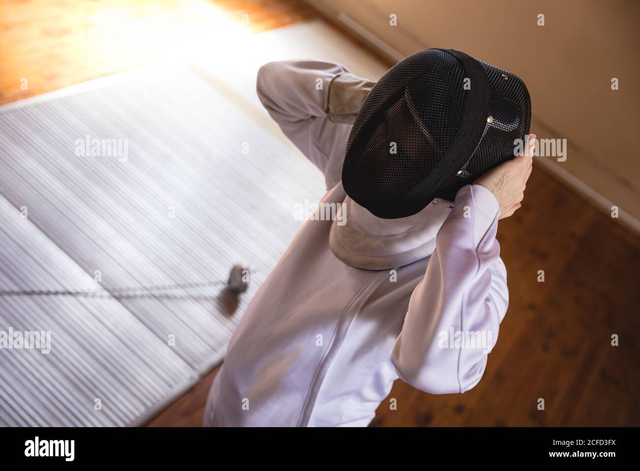 Man wearing fencing outfit Stock Photo - Alamy