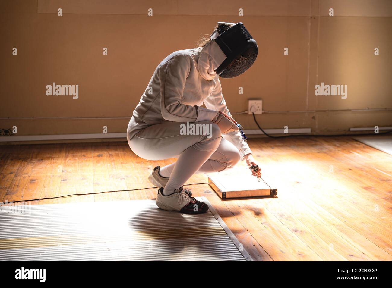Woman wearing fencing outfit Stock Photo - Alamy
