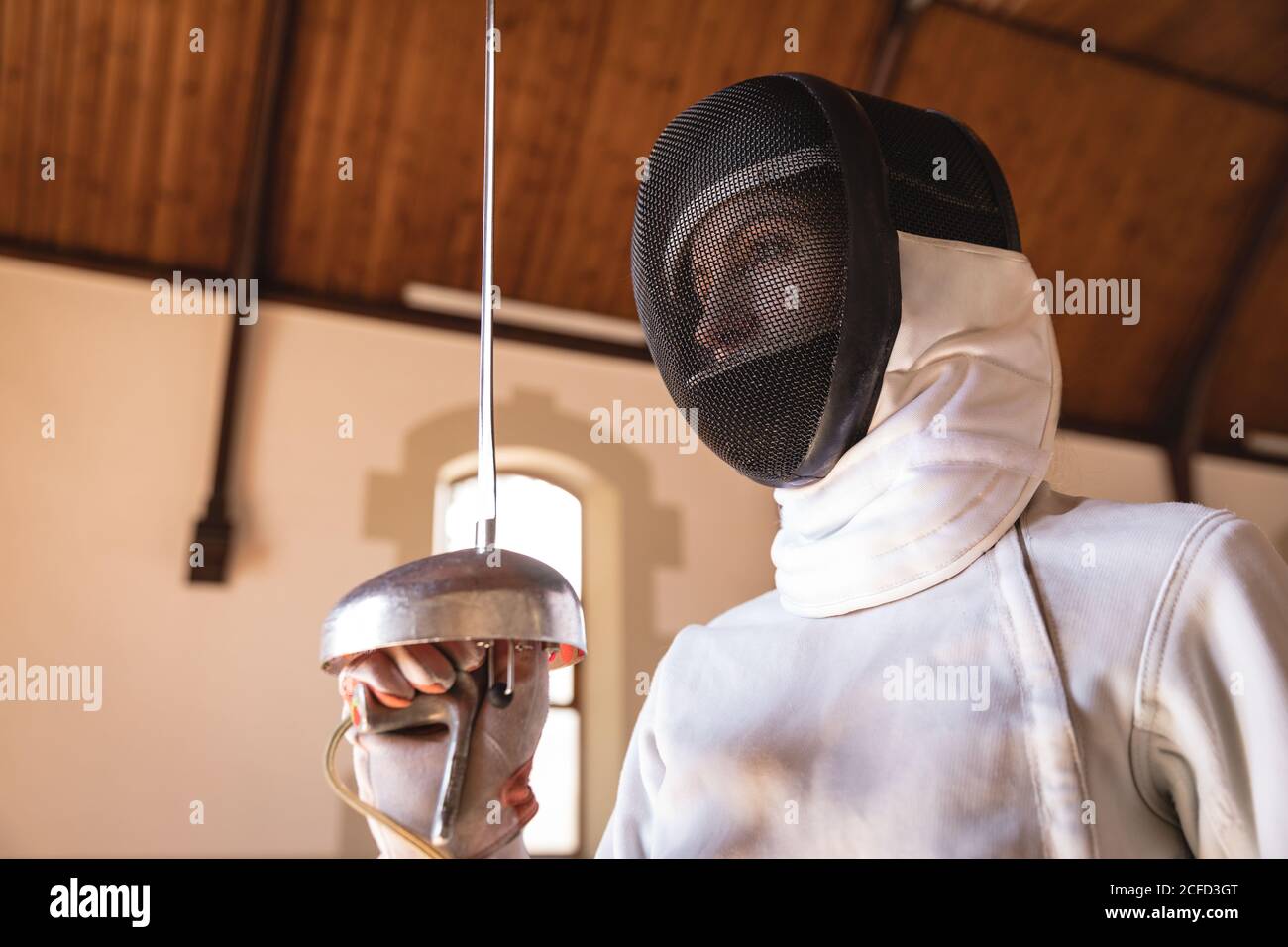 Woman wearing fencing outfit Stock Photo - Alamy
